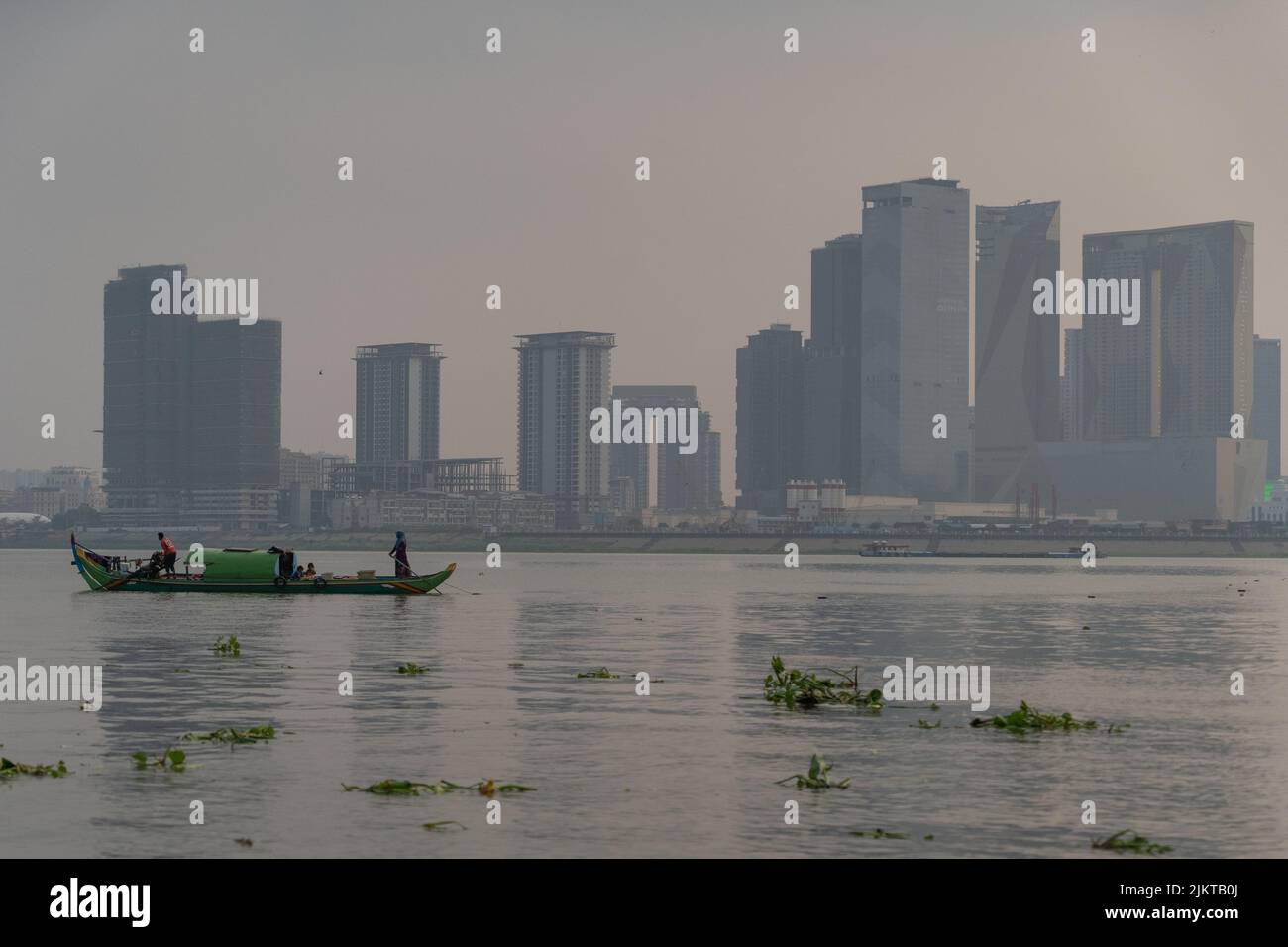 A silhouette of a fisherman on Tonle Sap Mekong junction in front of ...