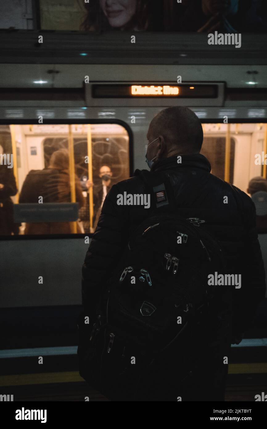 A back view of a man in a train station Stock Photo - Alamy