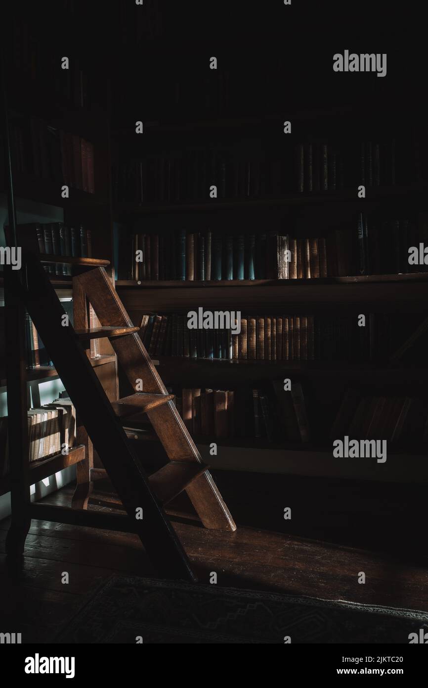 A beautiful view of a library in a dark room Stock Photo - Alamy