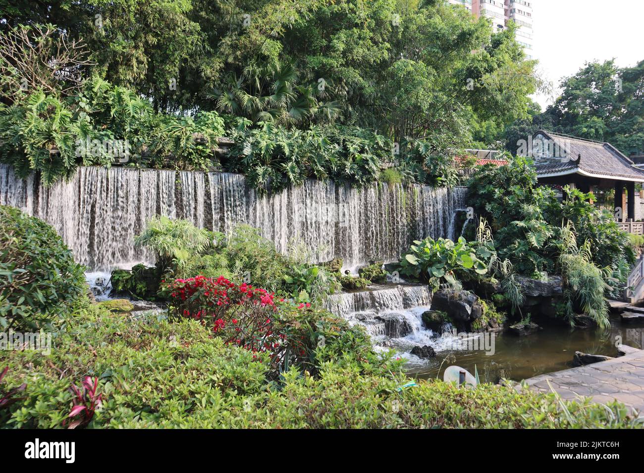 A view of a Japanese style botanical garden with waterfalls Stock Photo ...