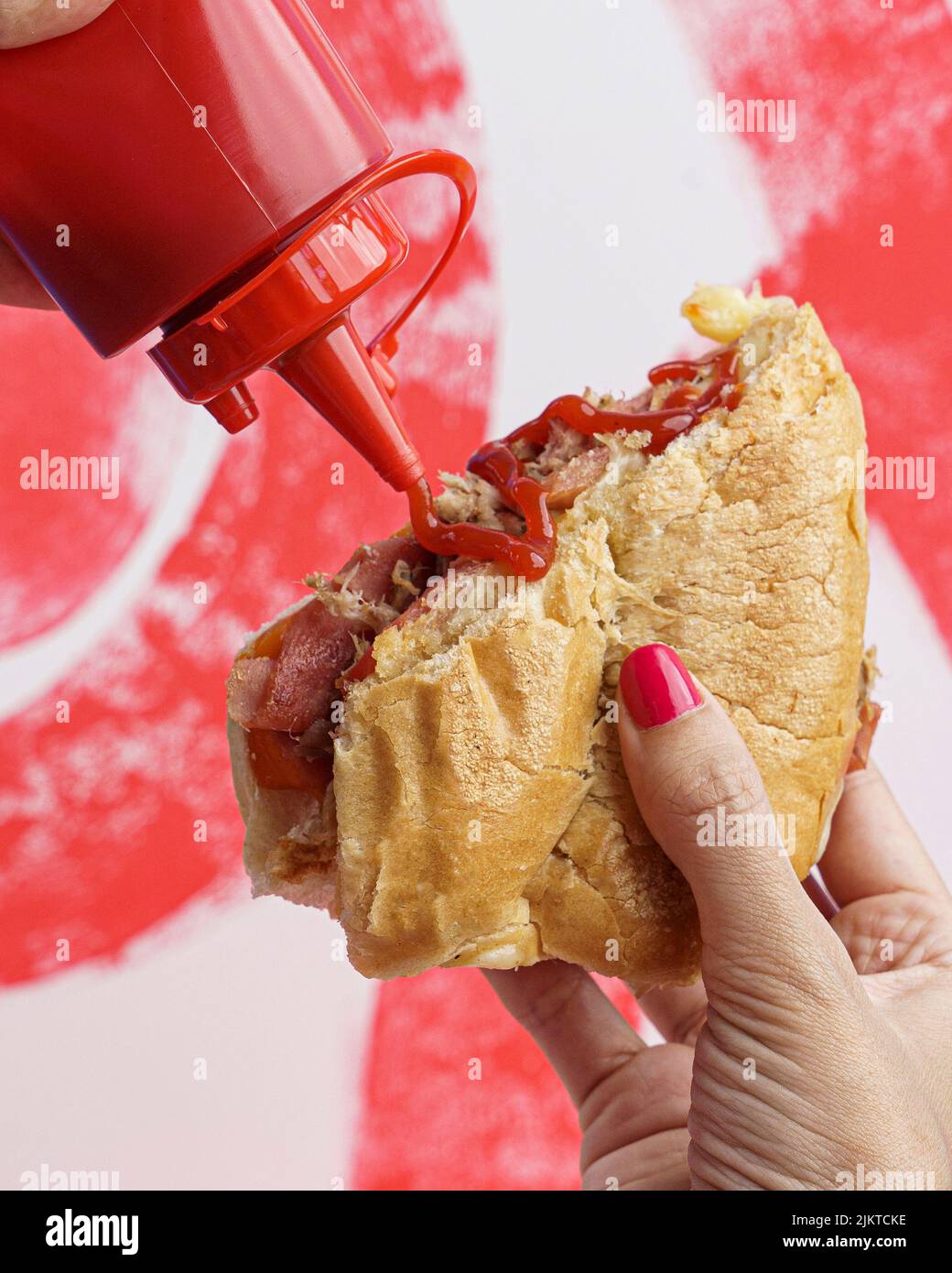 Person putting ketchup on sandwich hi-res stock photography and images ...