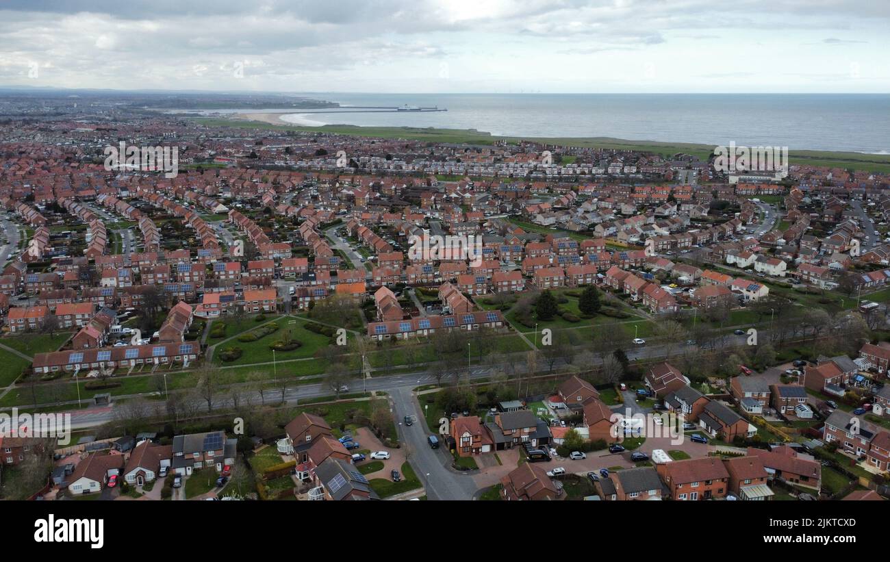 An aerial view of a rural neighborhood with similar houses on a coast ...