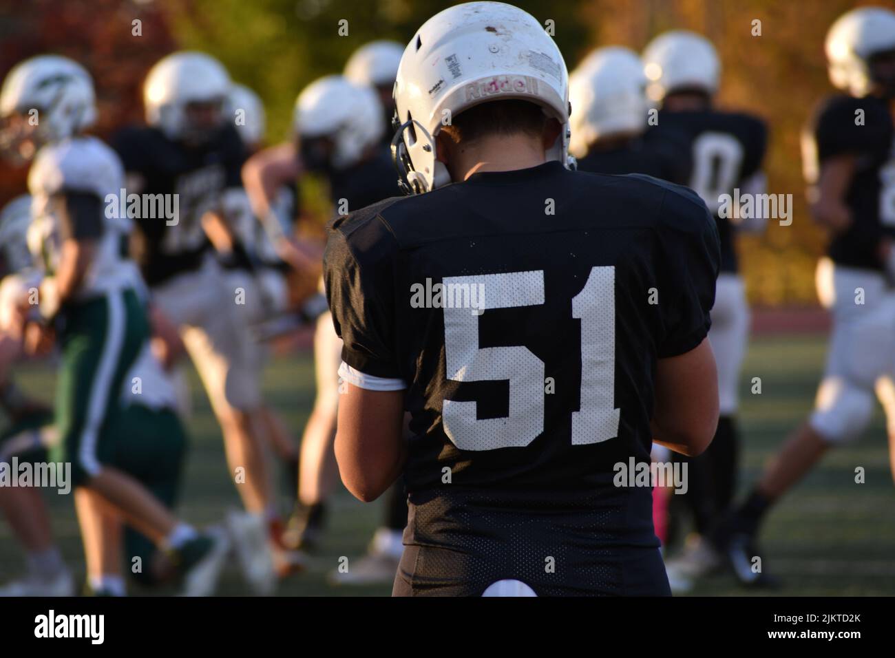 A back view of football players on a field Stock Photo - Alamy