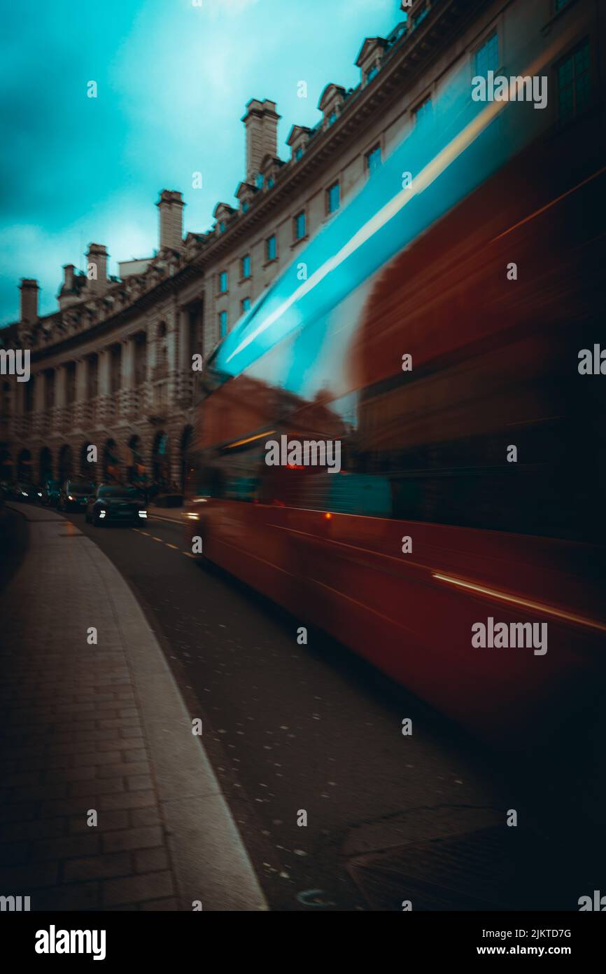 A vertical shot of a bus in motion against the historic buildings of ...