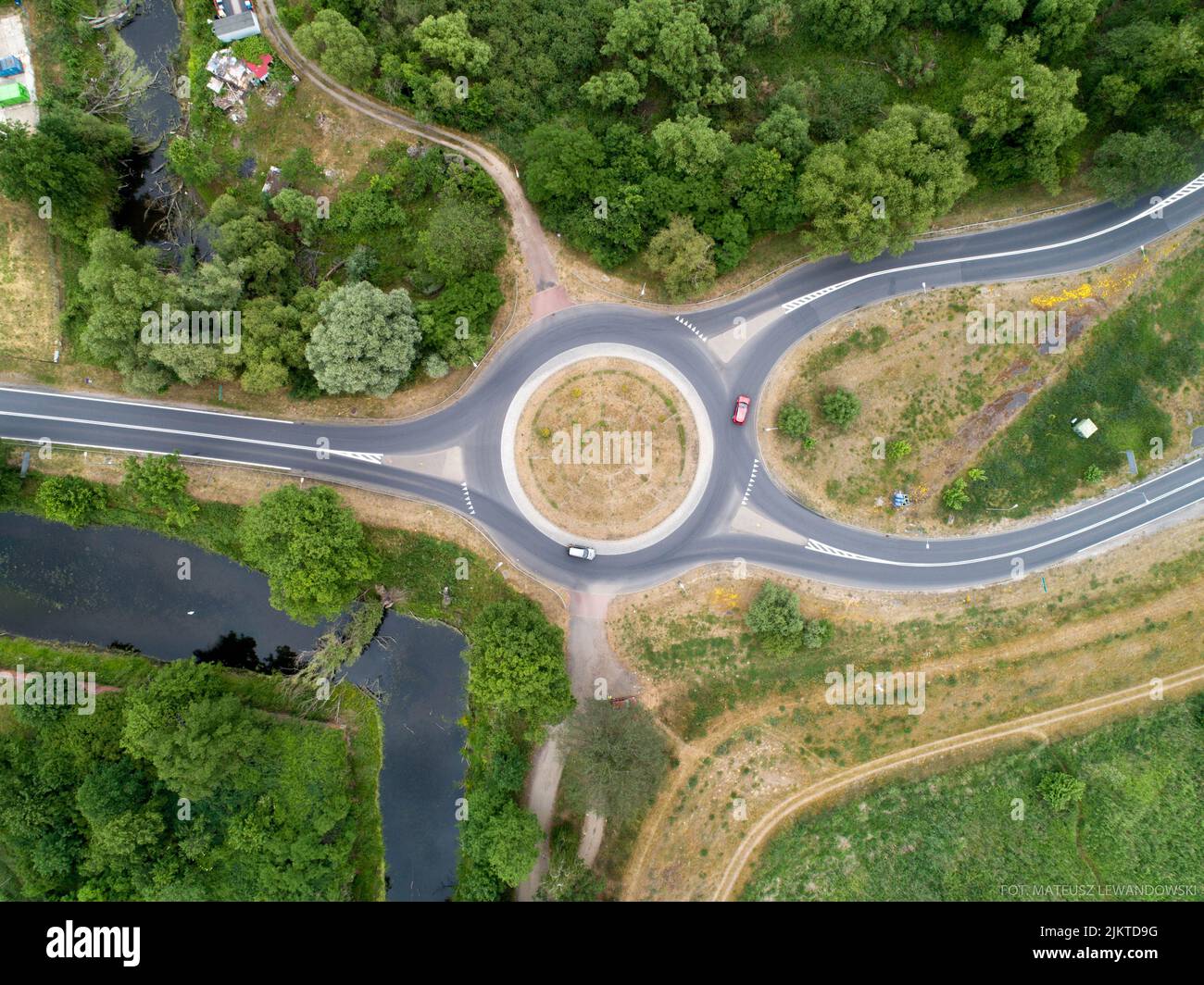 A top view of a roundabout surrounded by forest trees Stock Photo - Alamy