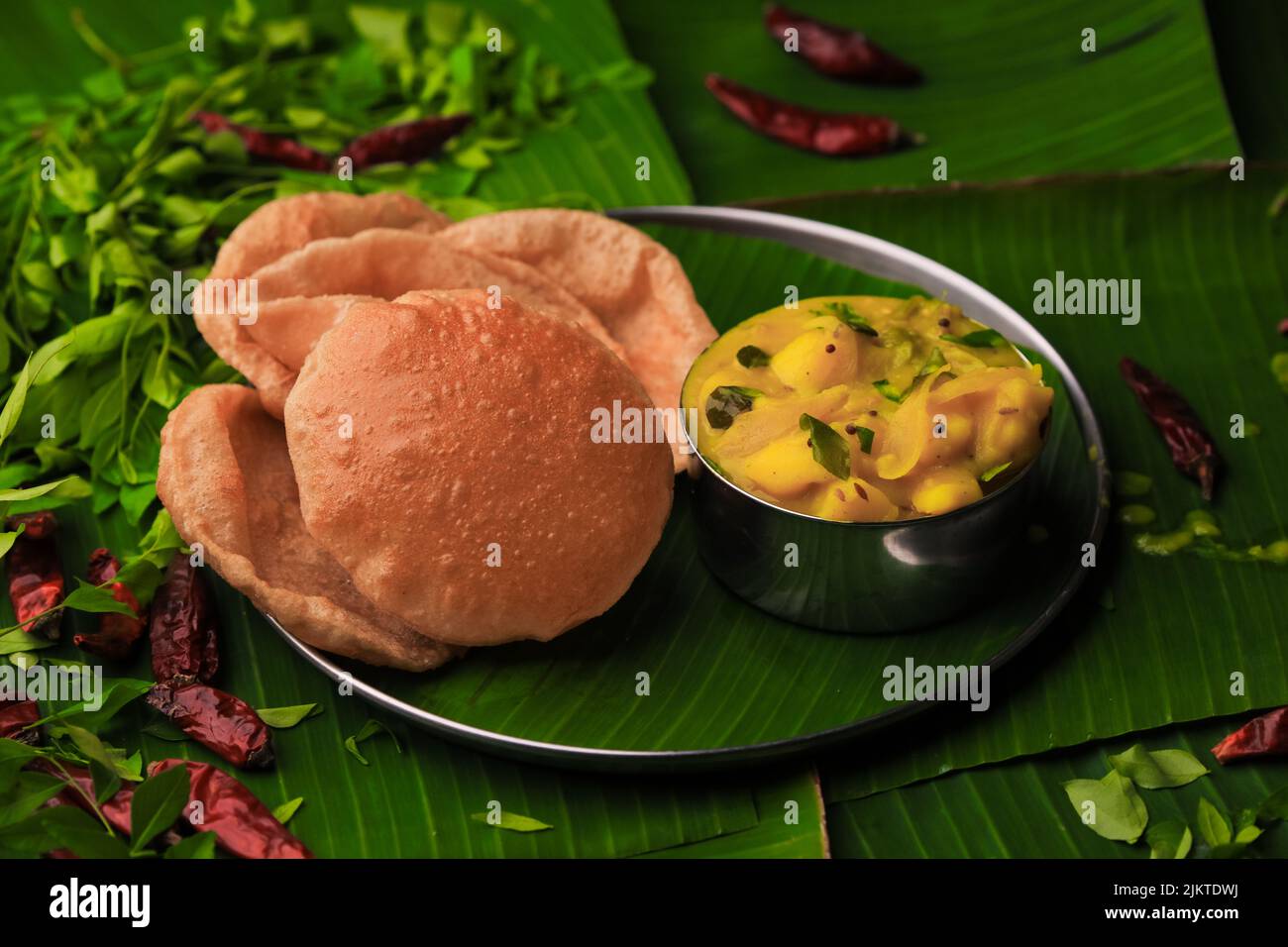 south indian famous breakfast poori or puri with potato curry served in ...