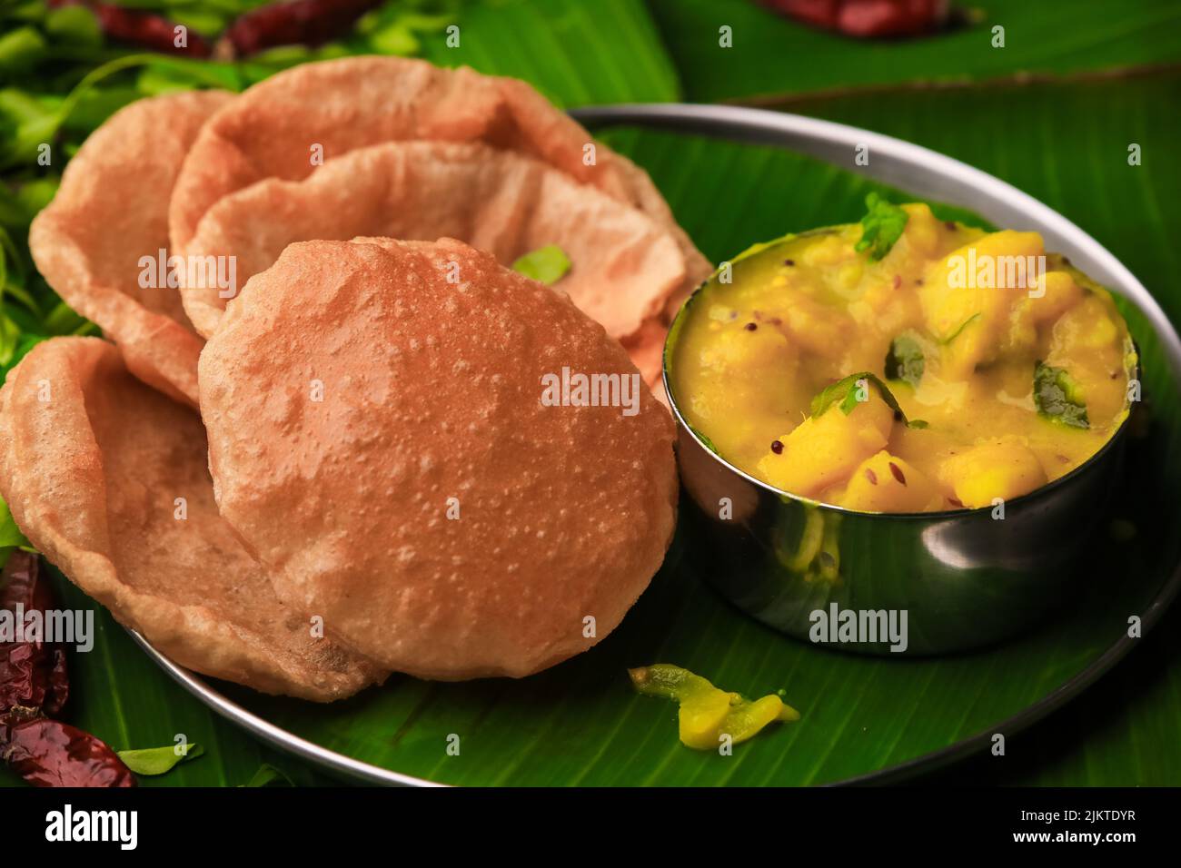 south indian famous breakfast poori or puri with potato curry served in ...