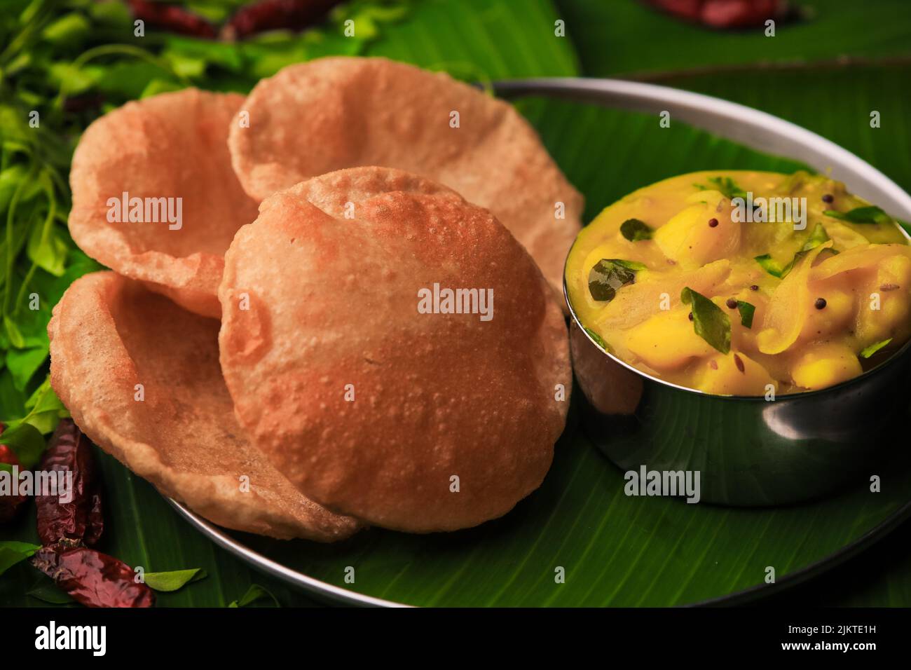 south indian famous breakfast poori or puri with potato curry served in ...