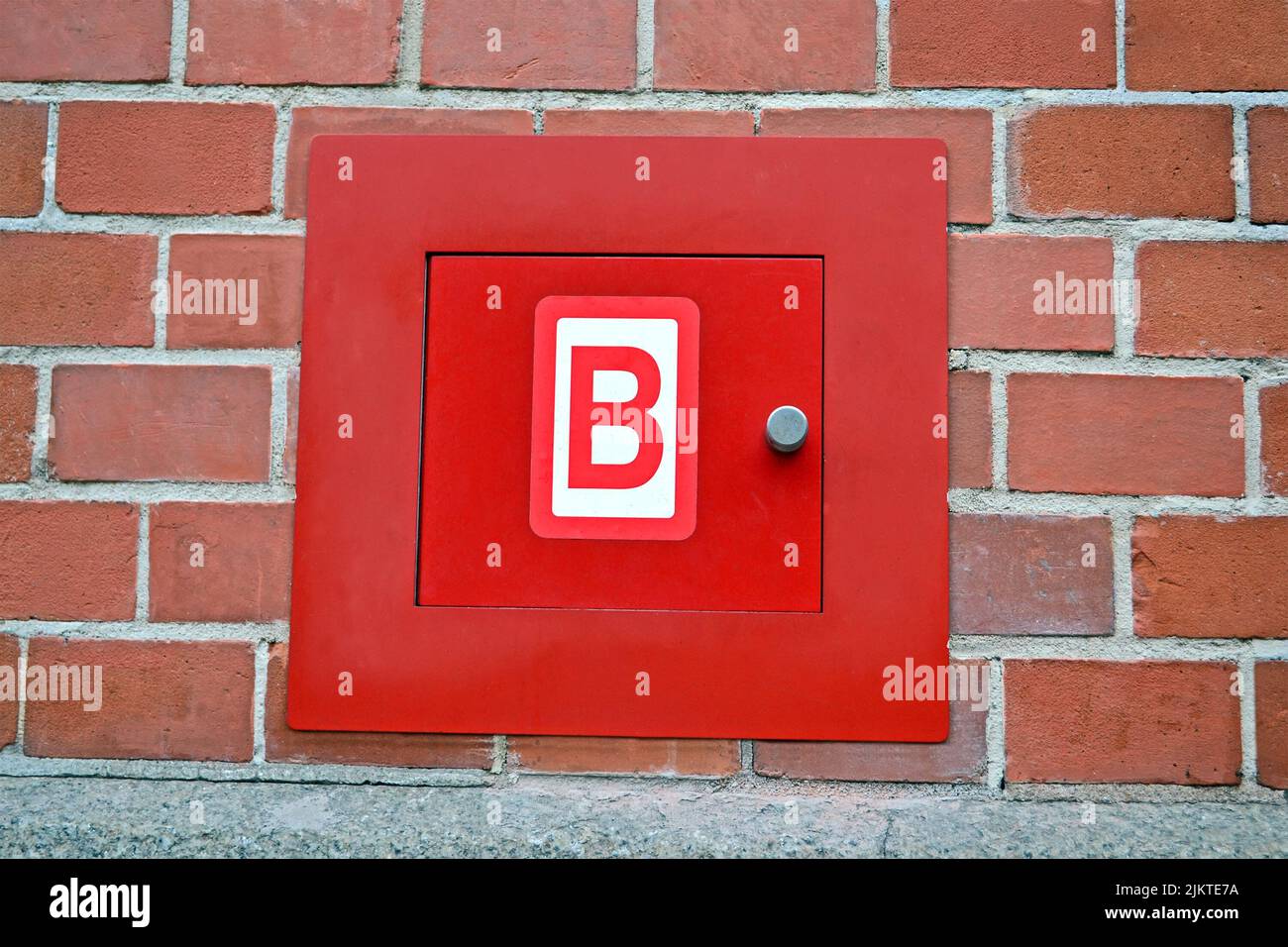 red fire box for hydrant on the red brick wall closeup, modern security ...
