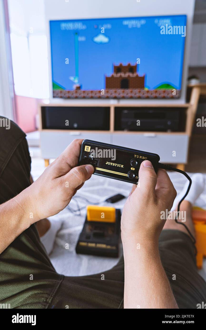 Male hands holding joystick from video-game console against background ...