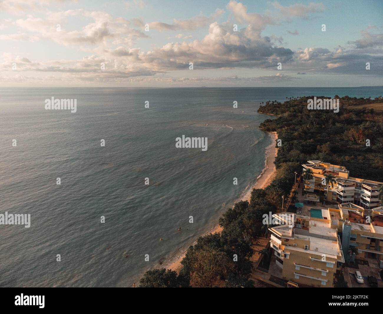 An aerial view of the sandy beach with buildings near the water at the ...