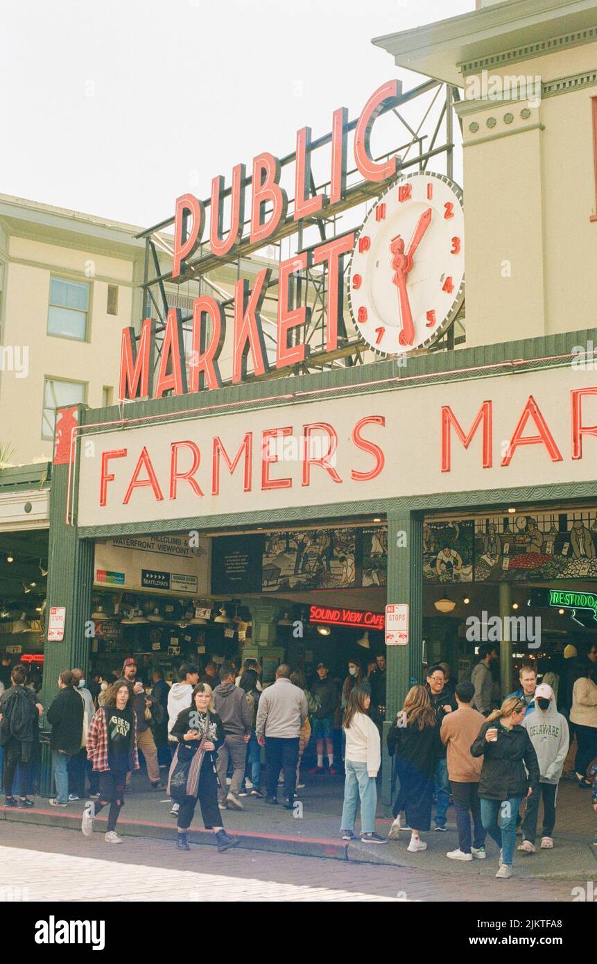 A beautiful shot of a crowd of people at Pike Place Market at noon on ...