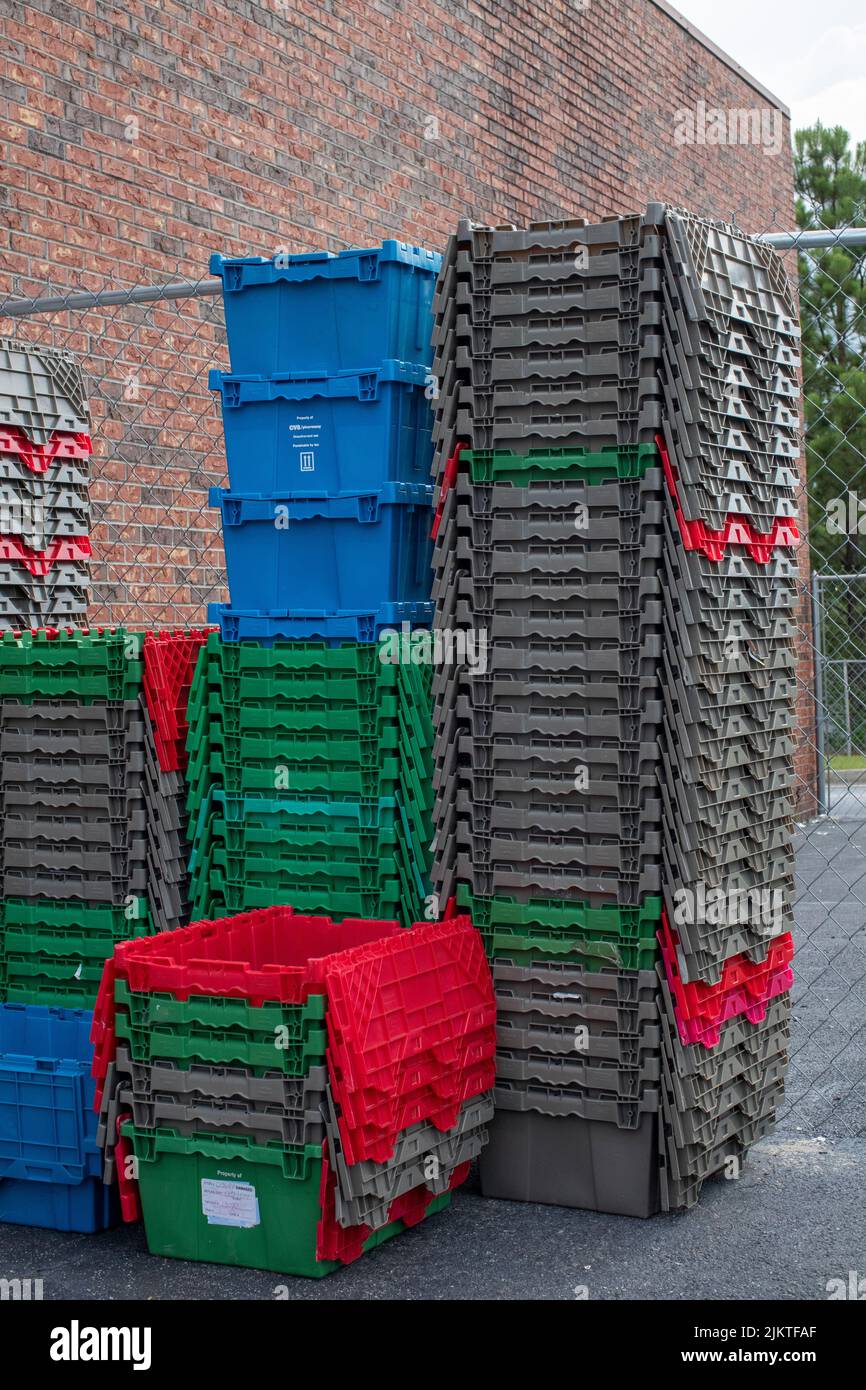 Augusta, Ga USA - 05 21 21: Stacks of empty colorful totes behind a ...