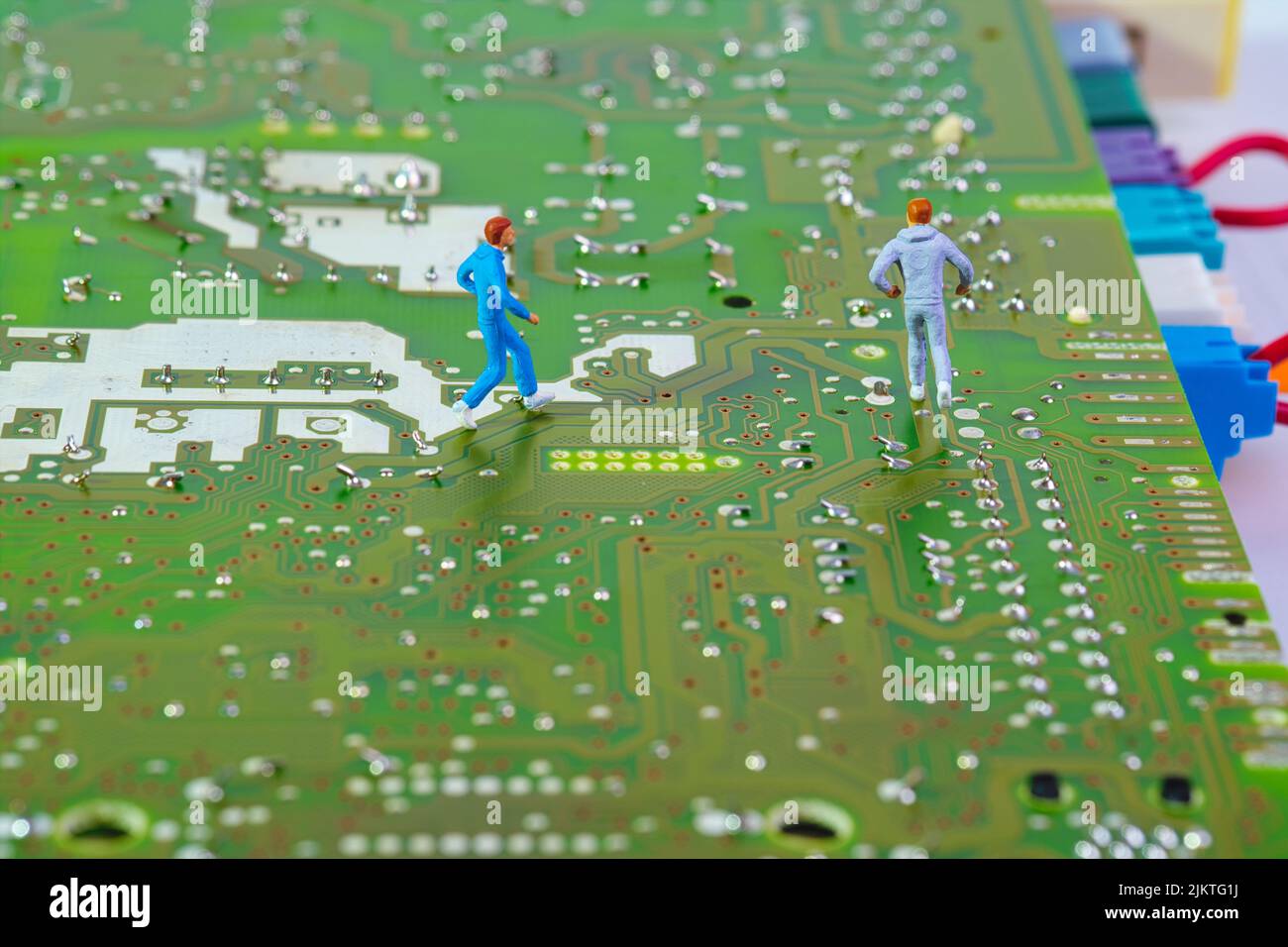 jogger running on an electronic circuit board,concept: circuit of ...