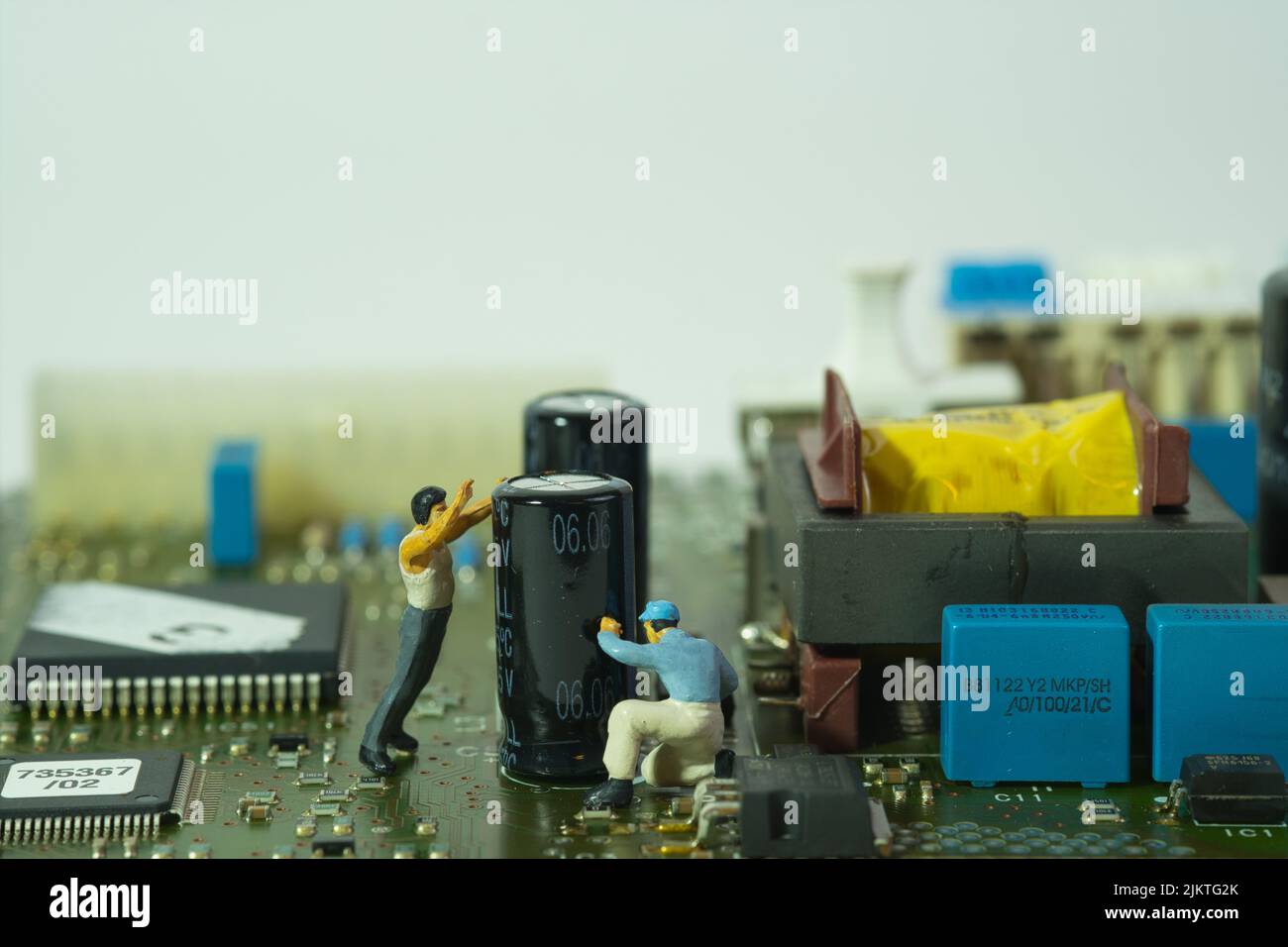 two workers inspect components on an electronic circuit board Stock ...