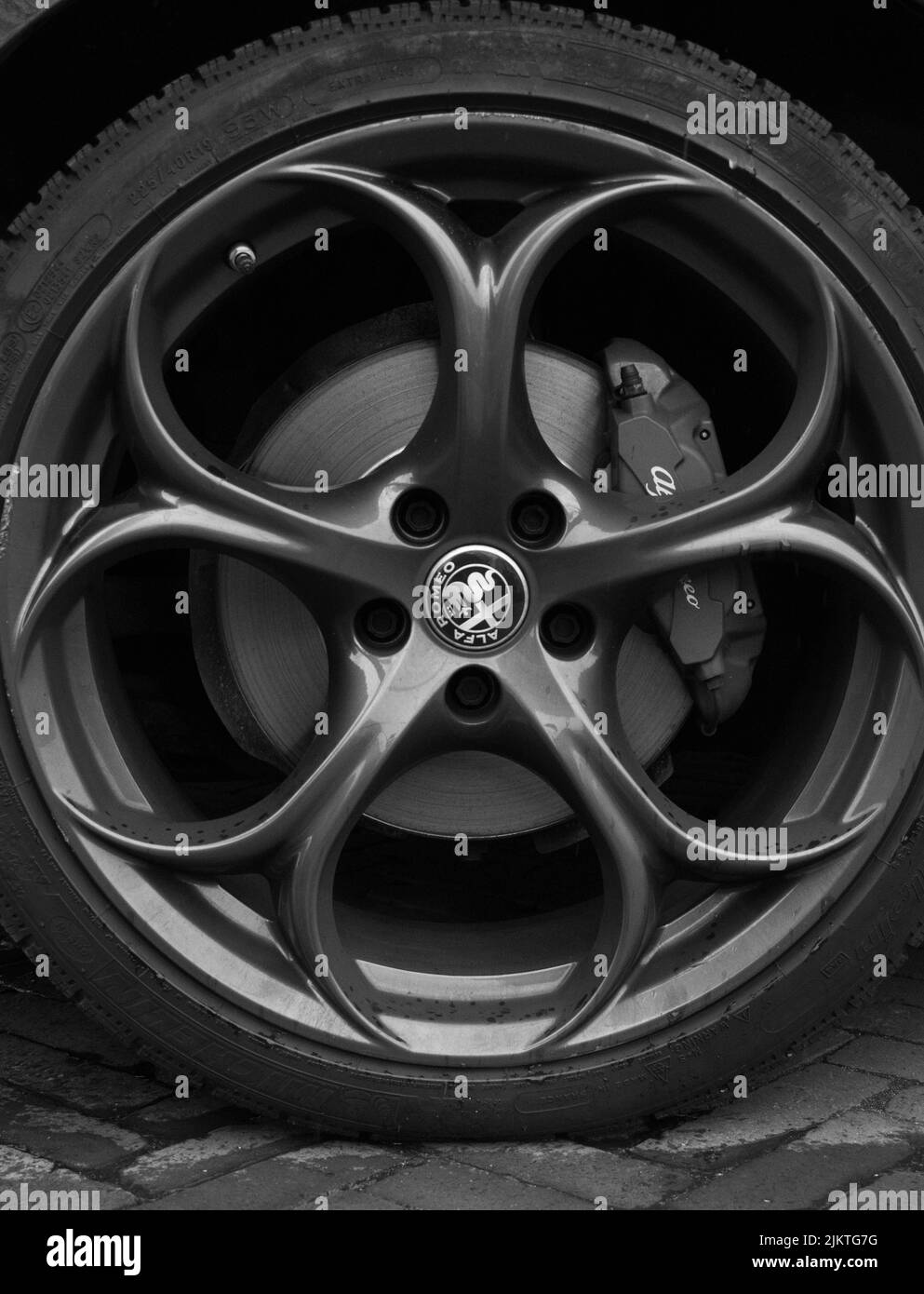 A grayscale view of an Alfa Romeo rim Stock Photo - Alamy
