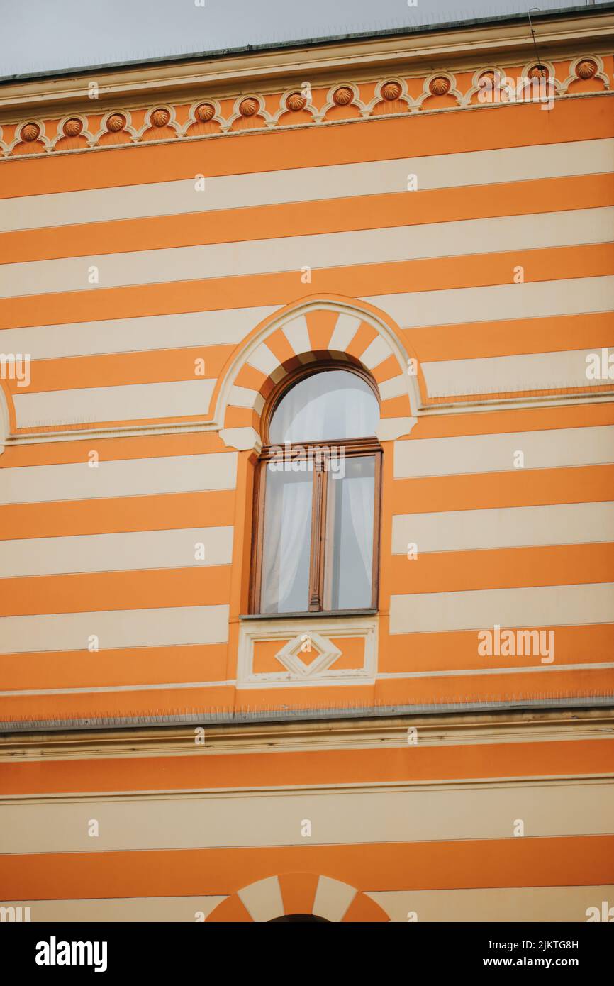 An aged building with a window and orange-white walls Stock Photo - Alamy
