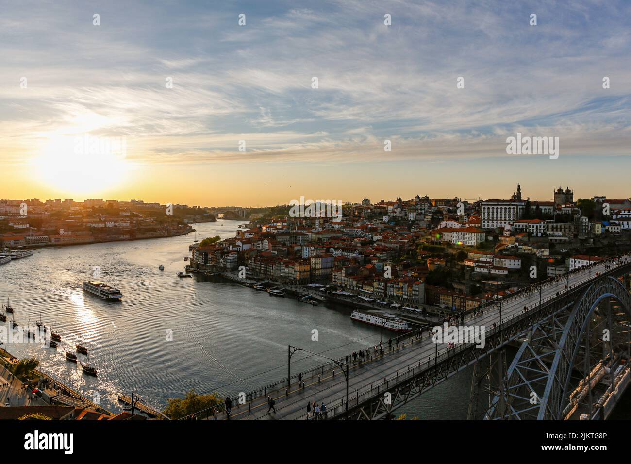 A scenic view of a bridge over the river surrounded by residential ...