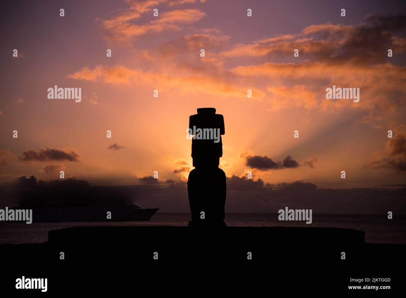 A scenic view of an antique Moai stone statue silhouette on Easter ...