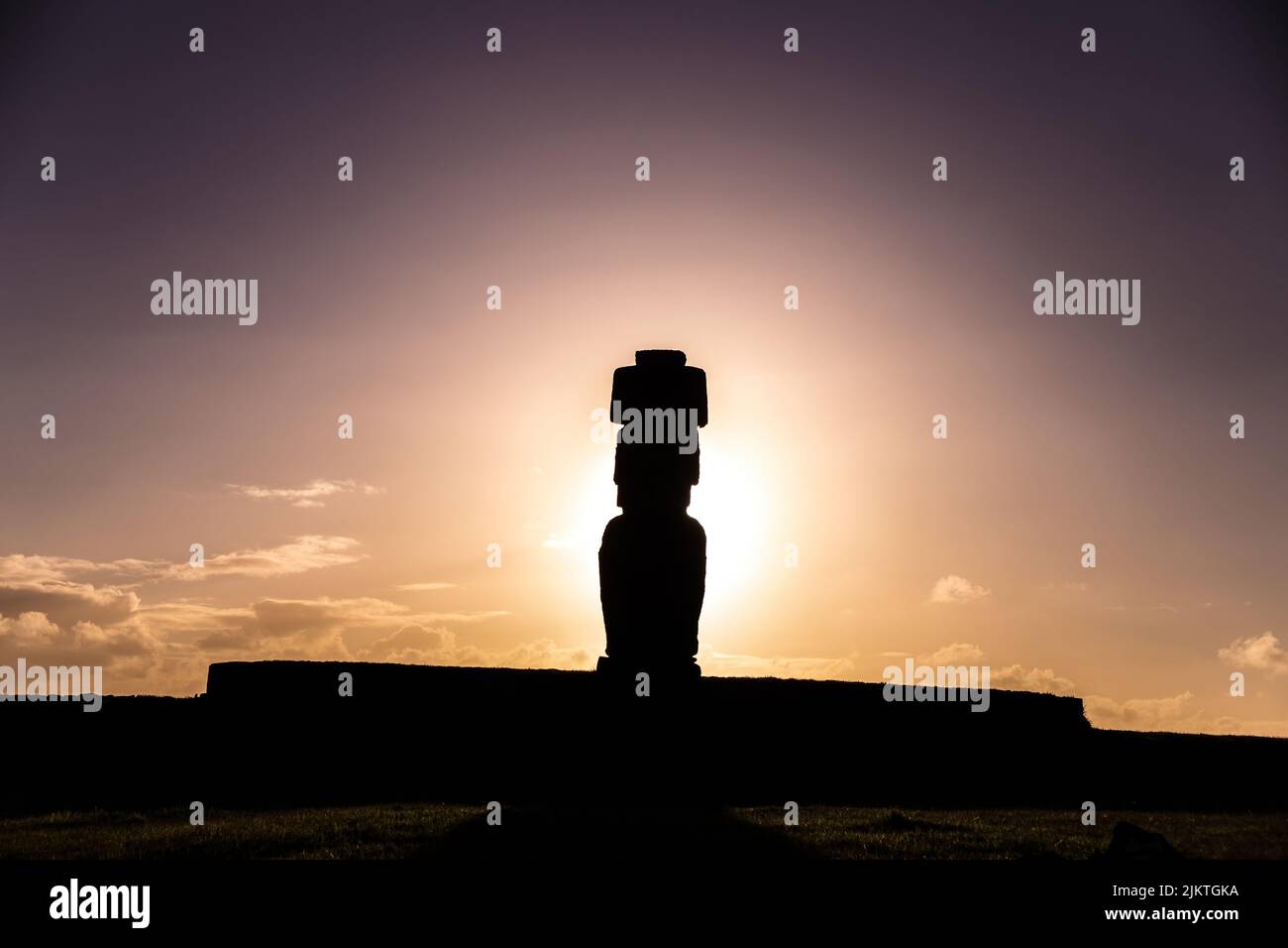 A scenic view of an antique Moai stone statue silhouette on Easter ...