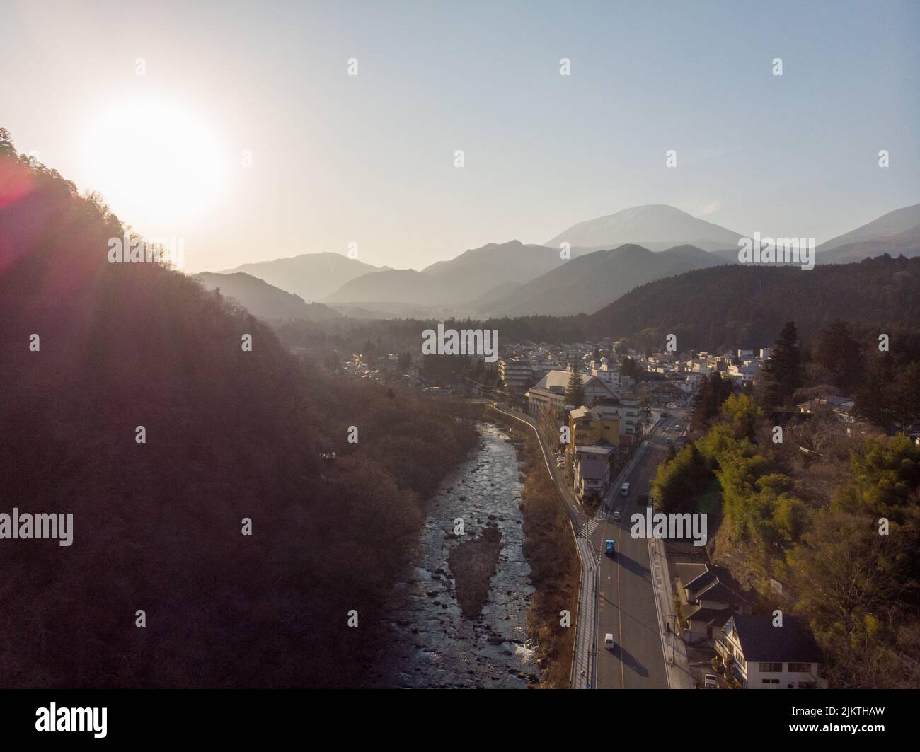 An aerial view of a cityscape with vehicles on the road next to a ...