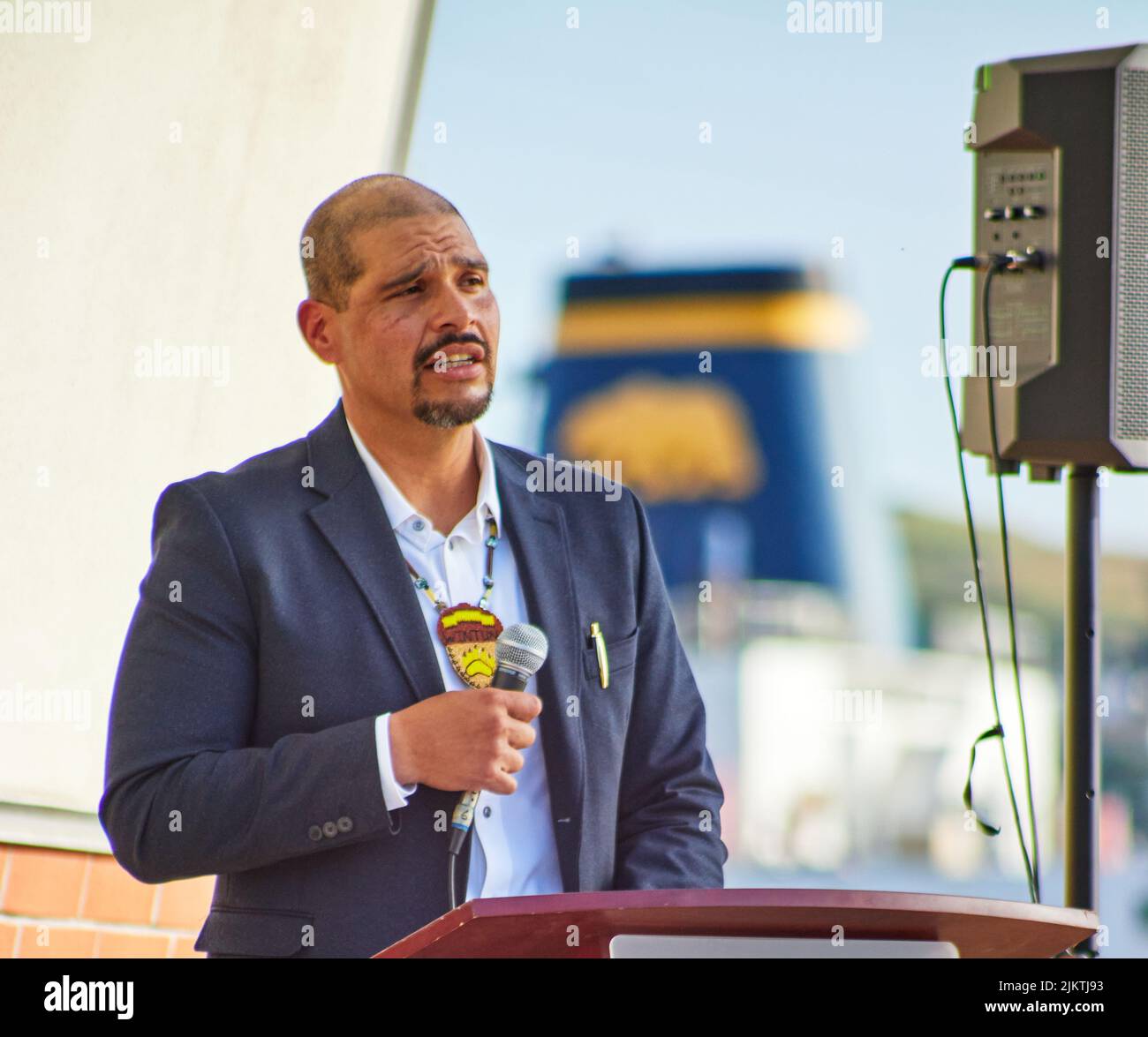 a shot of announcer speaking at ground blessing event Stock Photo - Alamy