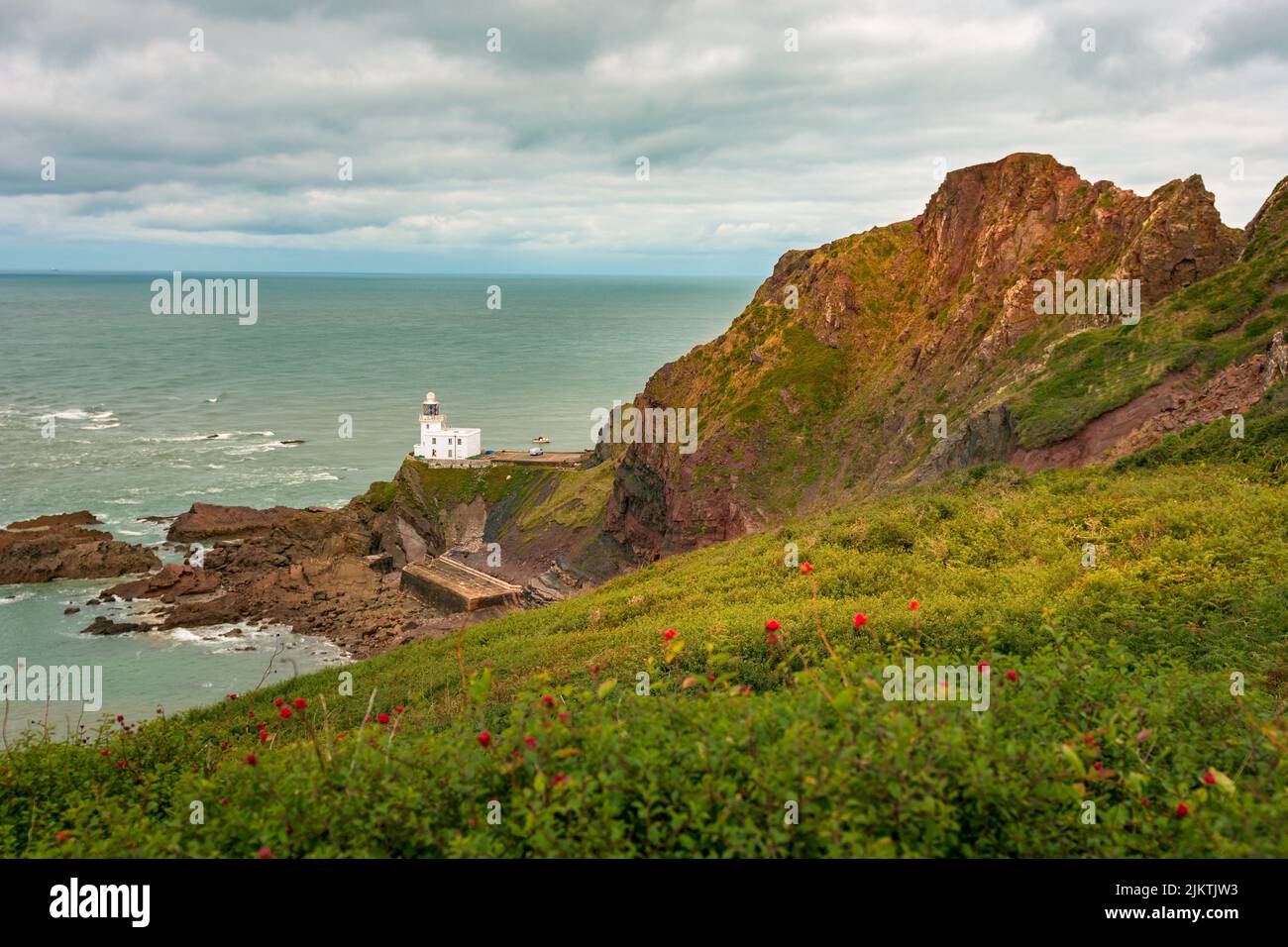 A high angle shot of Cape Roca with rugged vegetation-covered cliffs ...