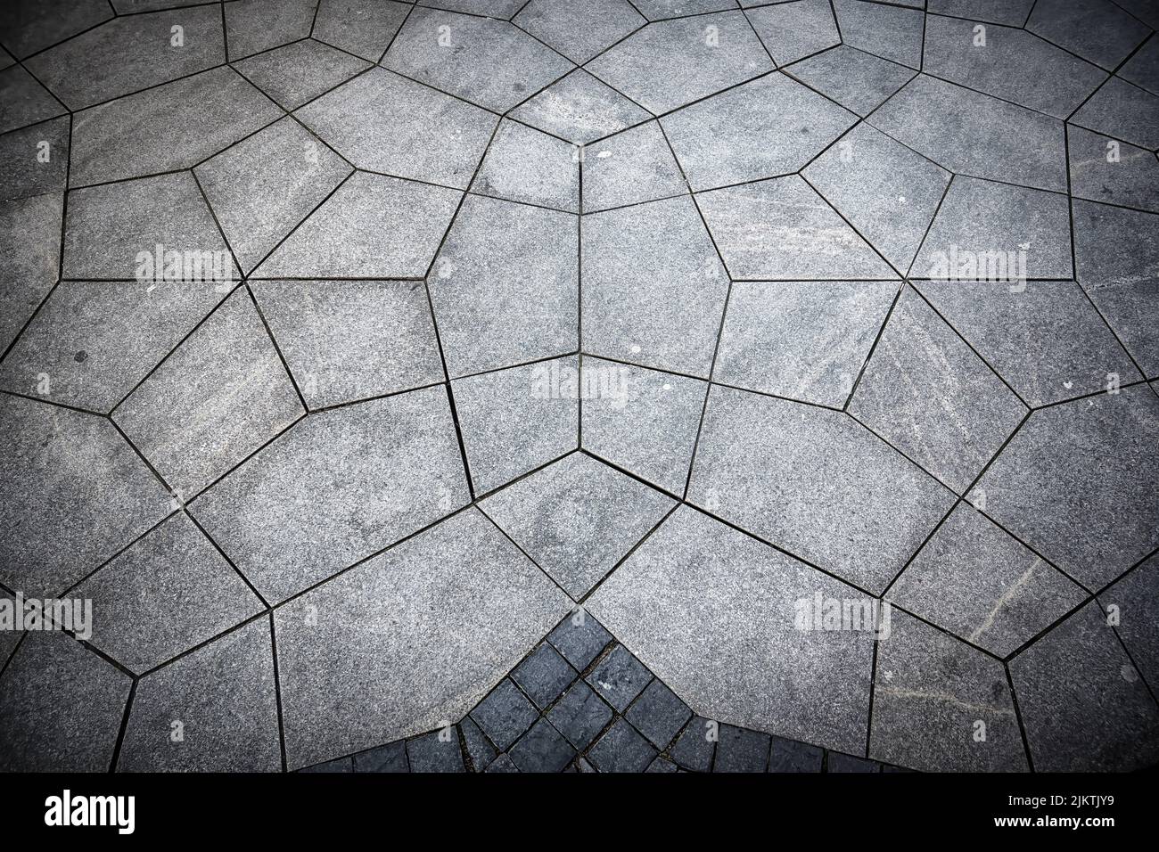 Ornate geometric paving pattern made of concrete slabs and stone ...