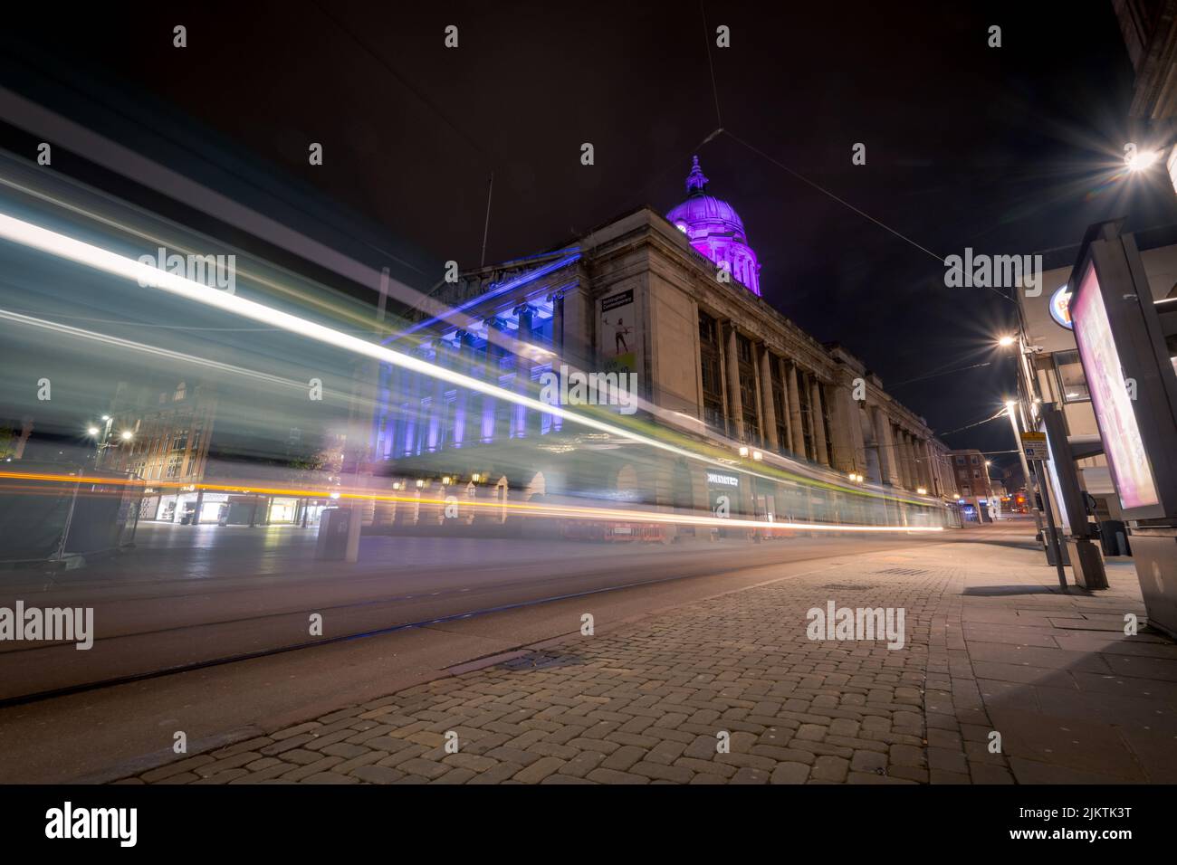 A long exposure of train lights in the empty city captured at night ...