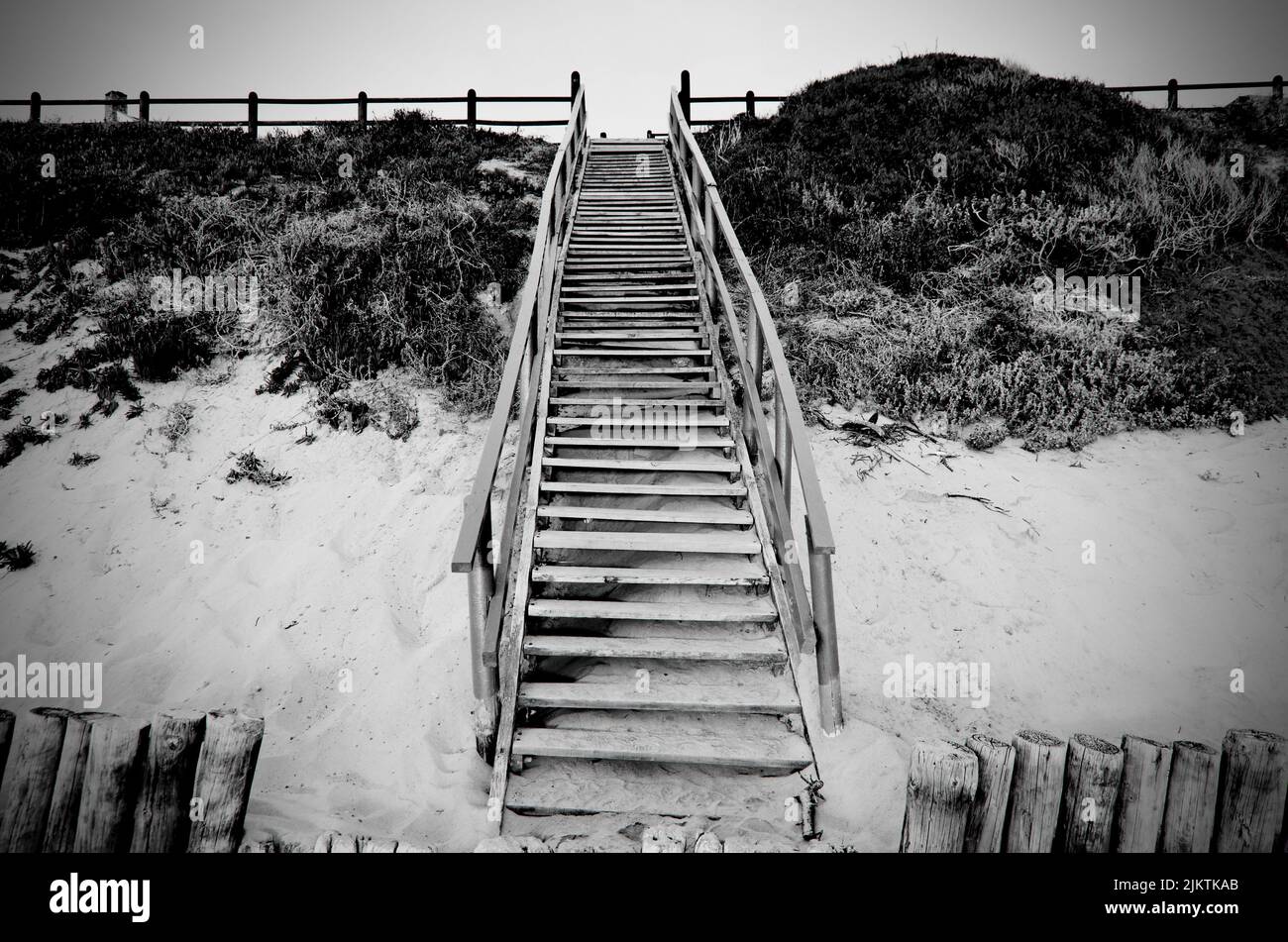 A grayscale view of a sandy beach with stairs Stock Photo - Alamy