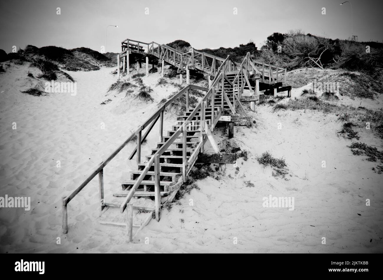 A grayscale view of a sandy beach with stairs Stock Photo - Alamy