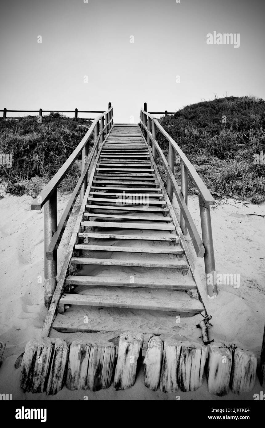 A grayscale view of a sandy beach with stairs Stock Photo - Alamy