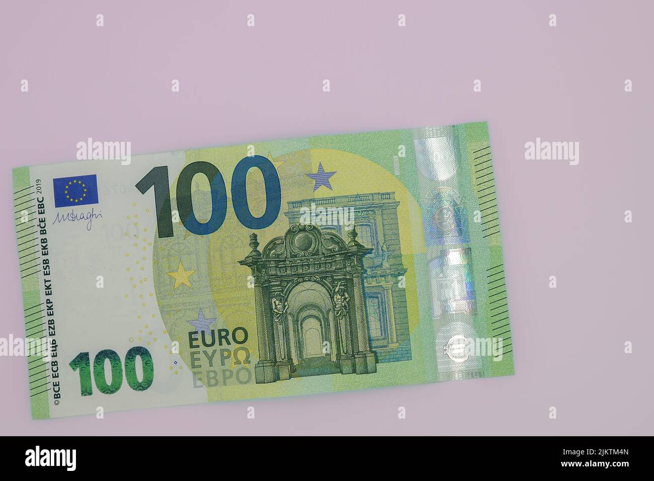 A closeup of a 100 Euro banknote on the white table Stock Photo - Alamy
