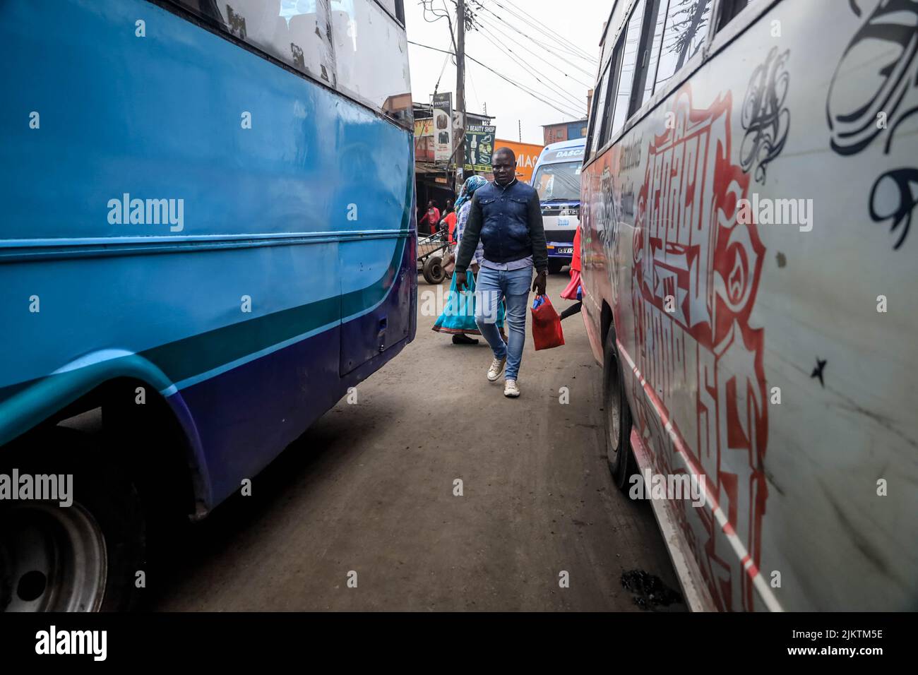 A Man walks past a busy bus terminal in Nairobi's Central Business ...