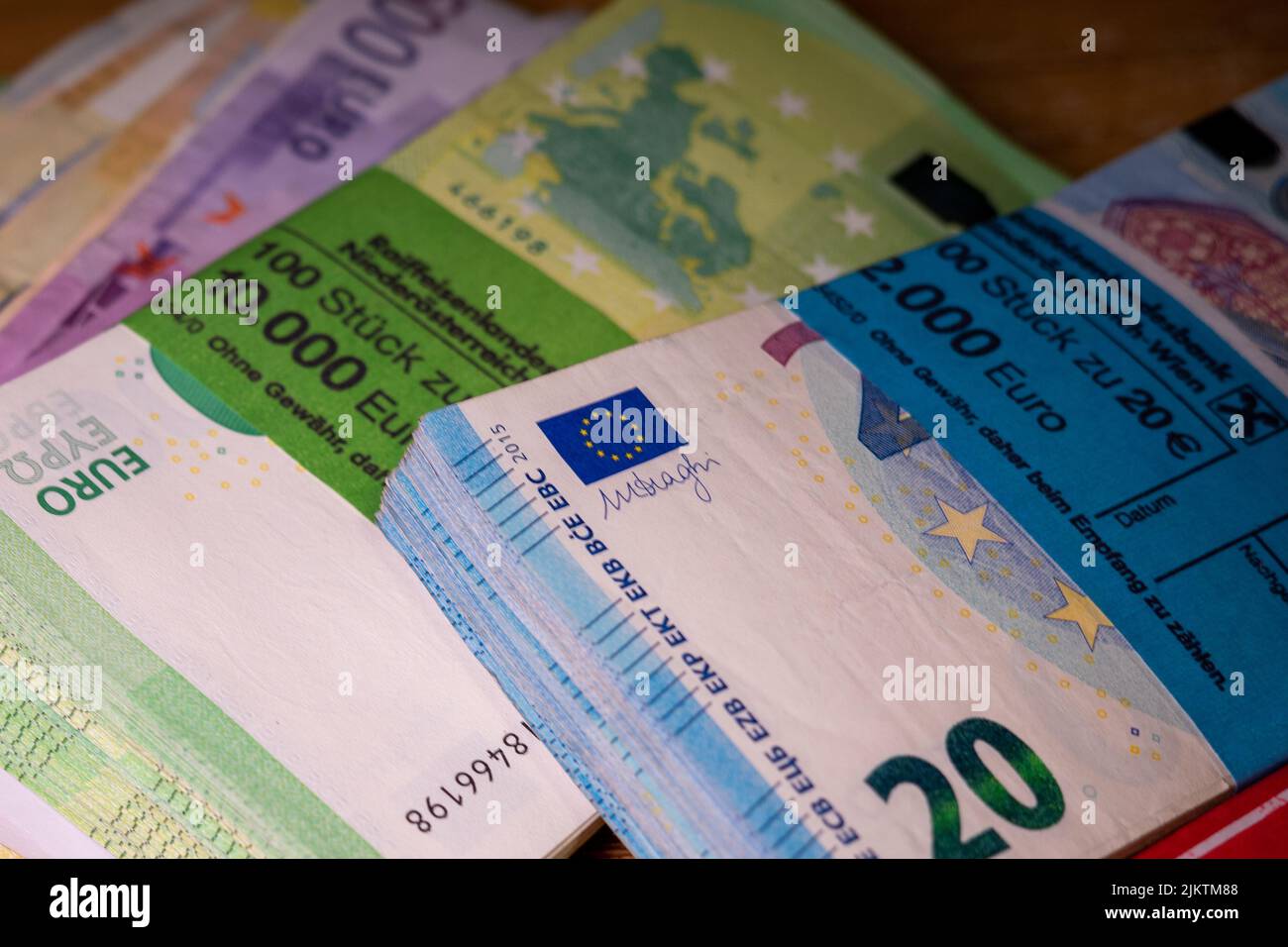 A closeup of a stack of 100 and 20 Euro banknotes bills from Raiffeisen ...