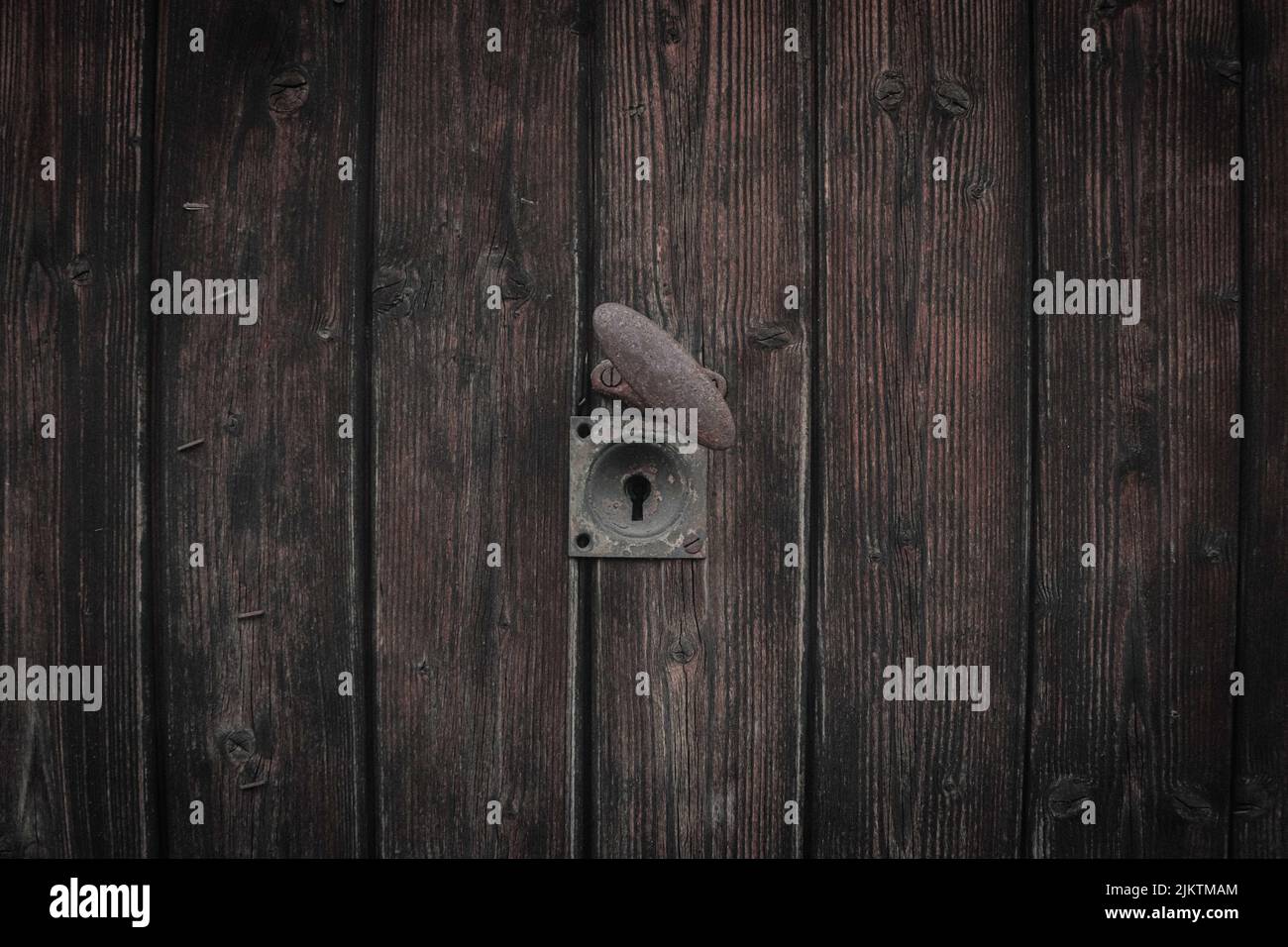 A front view of a wooden door with a lock Stock Photo - Alamy