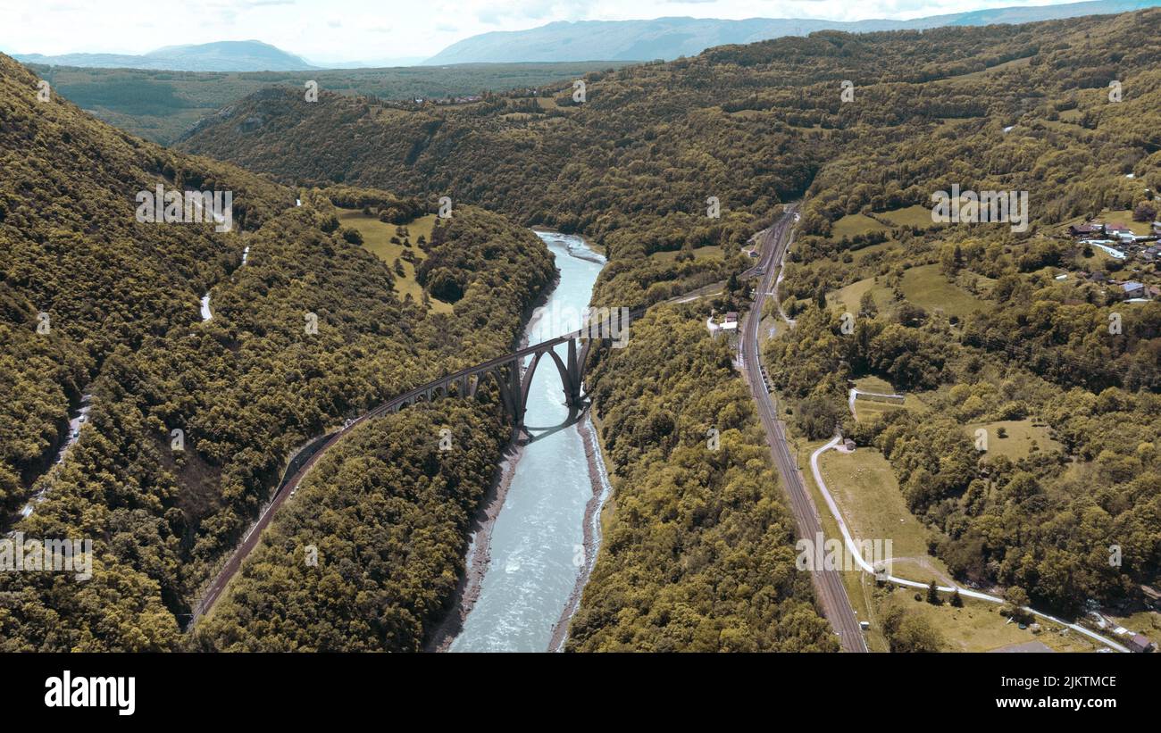 An aerial view of a bridge over the river amount fascinating nature in ...