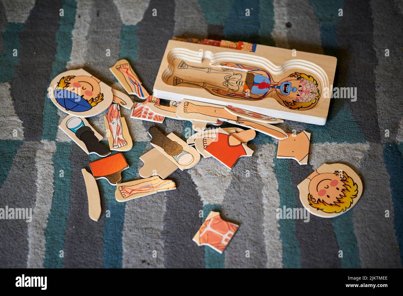 A Top View Of A Wooden Table Game Of A Human Body Puzzle On A Carpet A Top View Of A Wooden Table Game Of A Human Body Puzzle On A Carpet