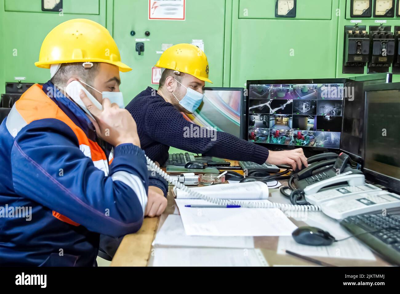 A beautiful shot of workers answering calls next to computers with a ...