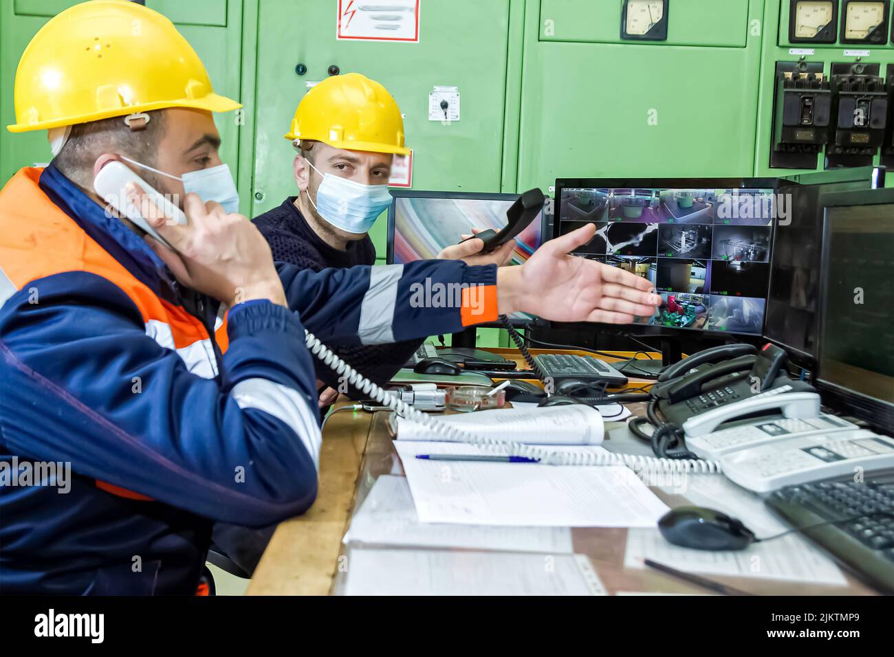 A beautiful shot of workers answering calls next to computers with a ...