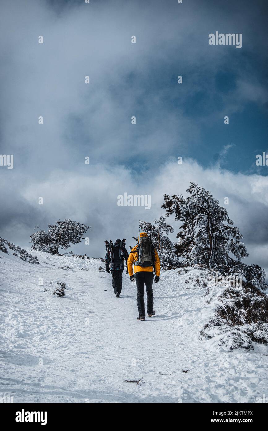 Two people climbing the snow-filled mountain Stock Photo - Alamy