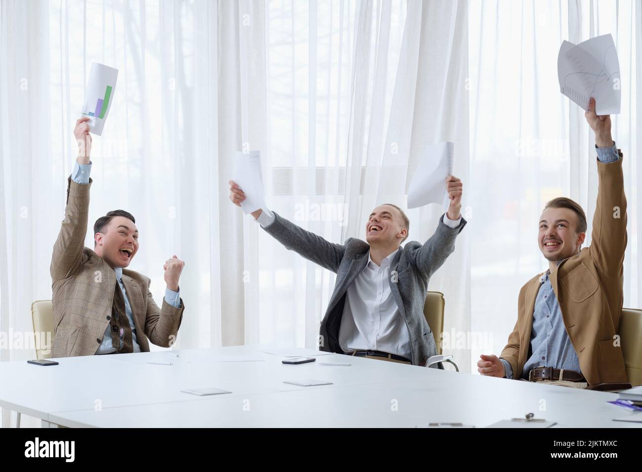 business success happy laughing men celebrating Stock Photo - Alamy