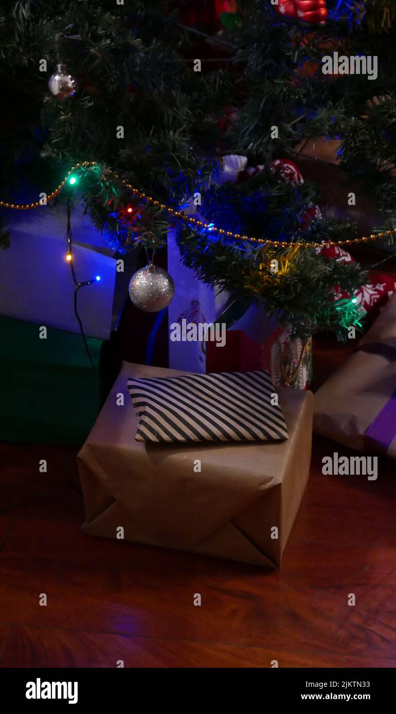A vertical shot of gift boxes under the Christmas tree Stock Photo - Alamy