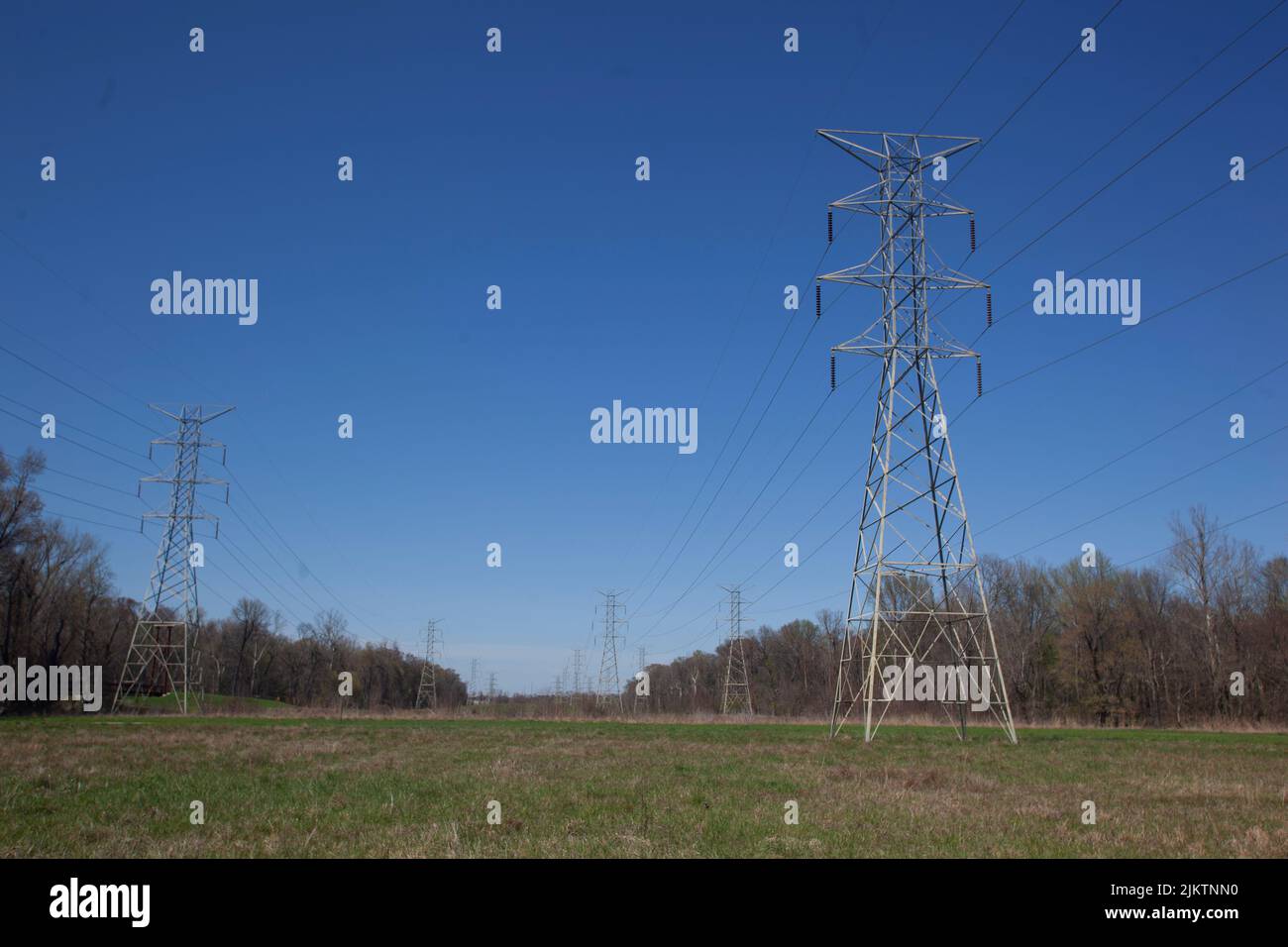 A view of high voltage transmission towers in the autumn countryside Stock Photo - Alamy