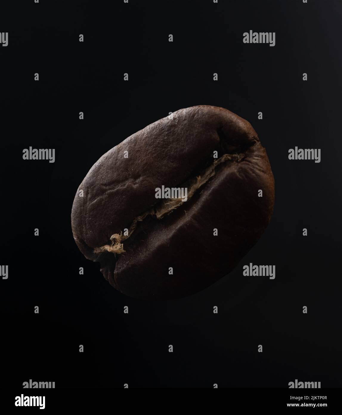 A floating coffee bean on a black gradient background Stock Photo - Alamy