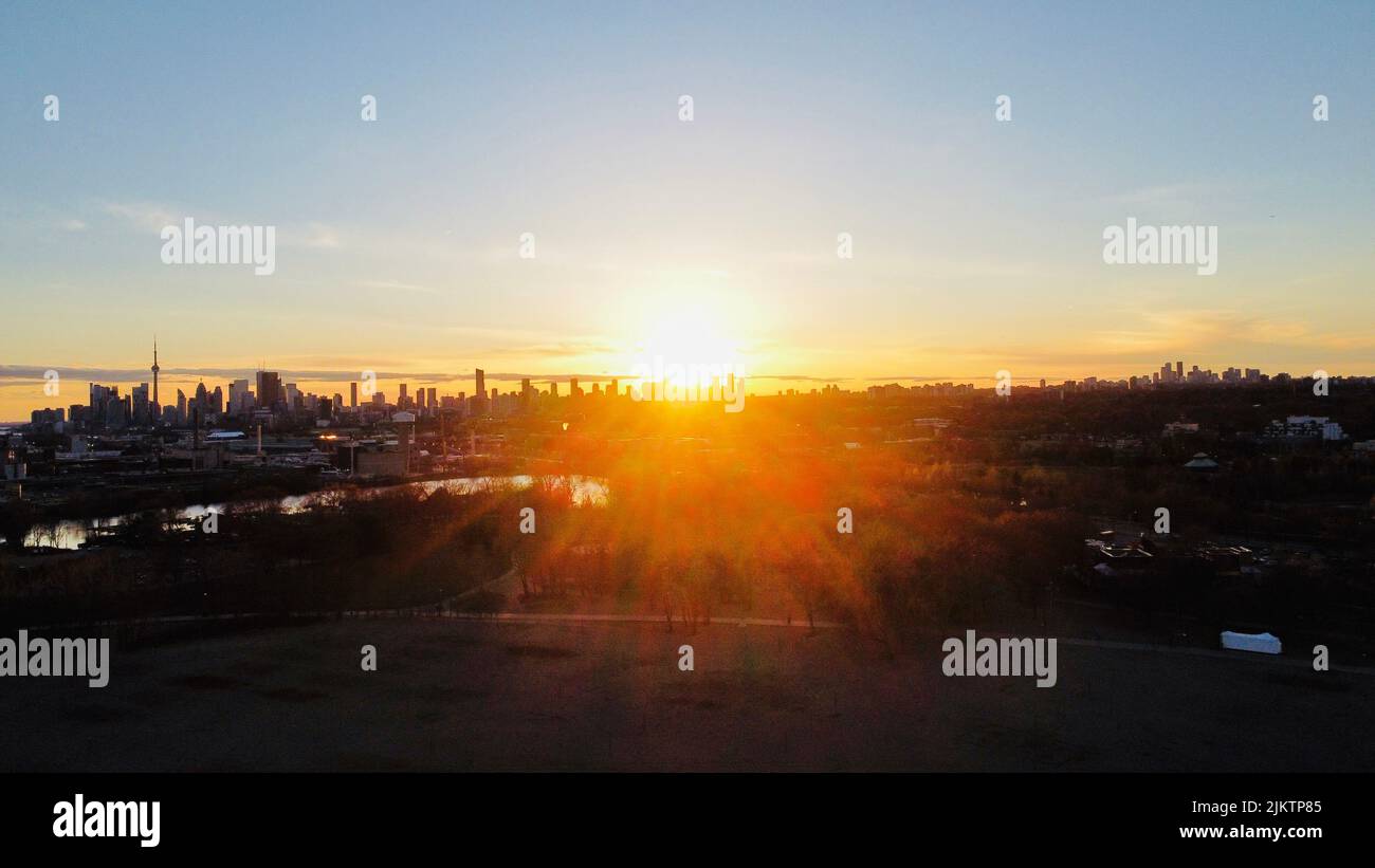 The bright shining sunrise over the city Stock Photo - Alamy
