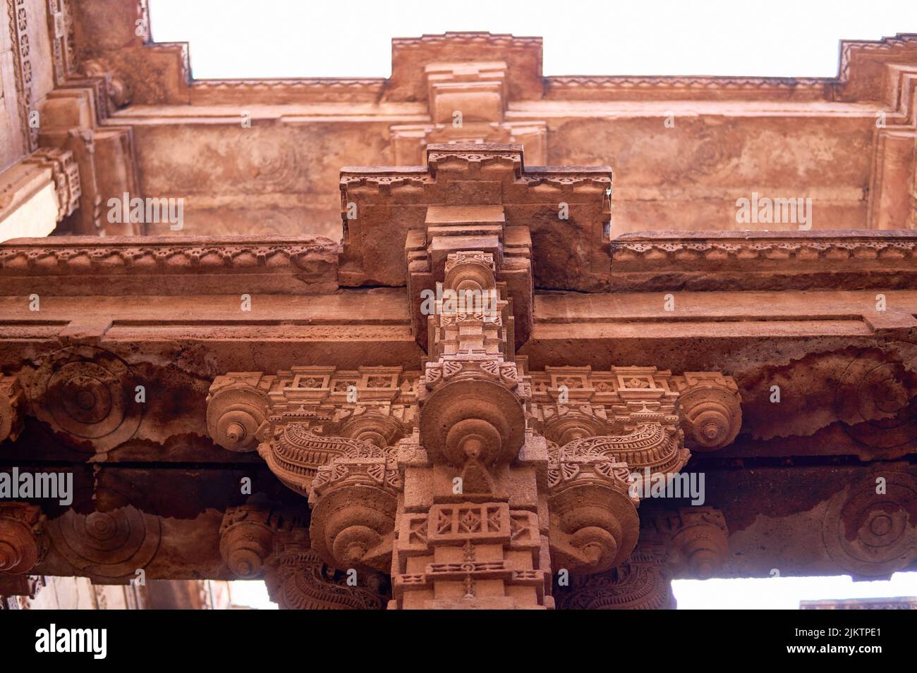 A low angle shot of the carved pillar in Adalaj Stepwell or Rudabai ...