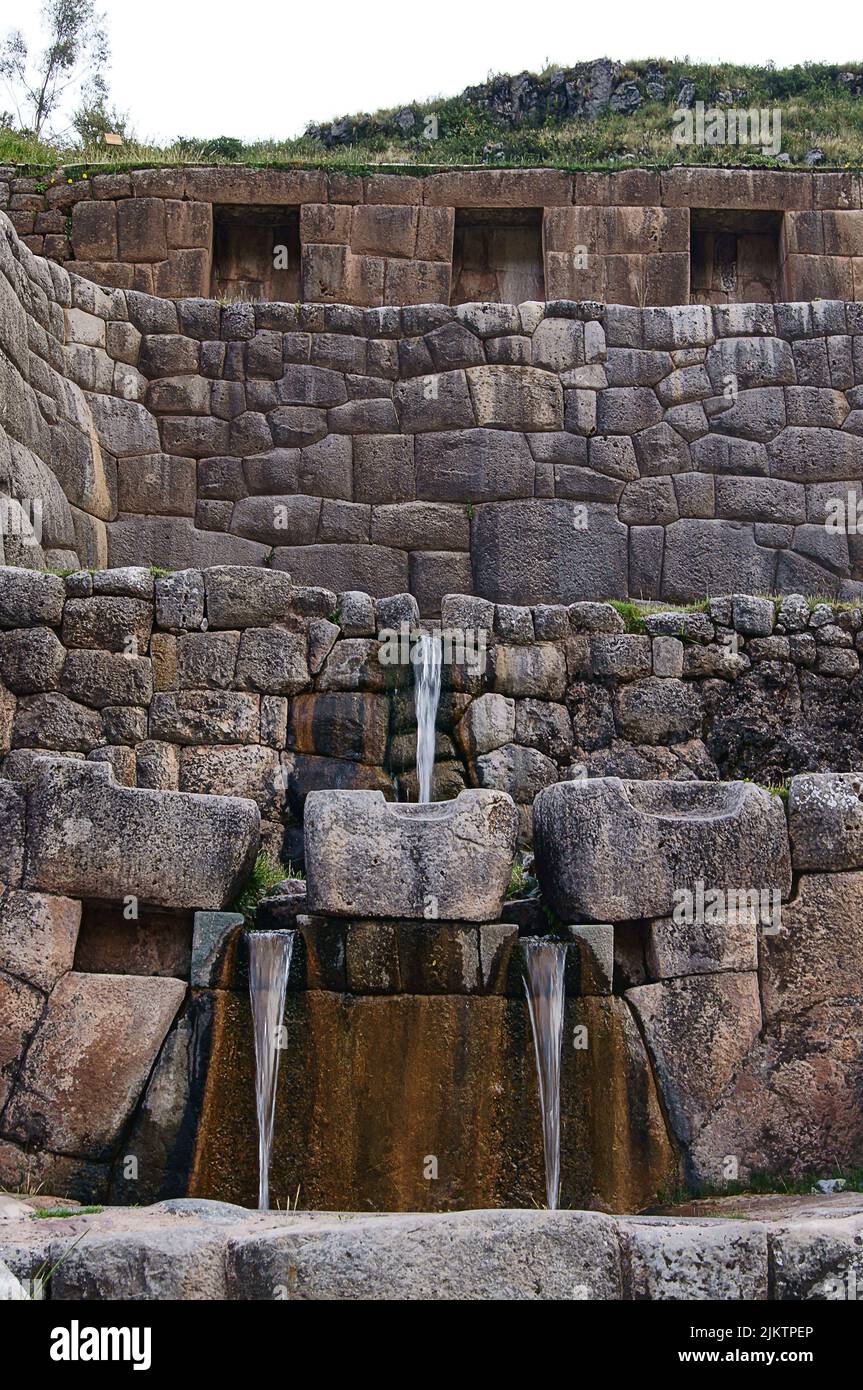 A vertical shot of Tambomachay with fresh spring water in Cusco, Peru ...