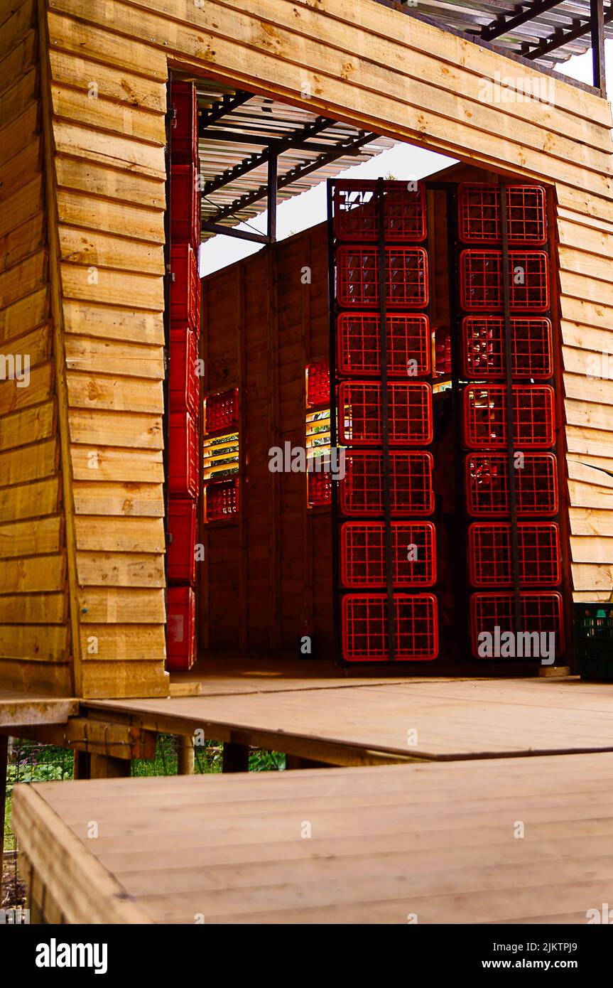 A vertical ground-level shot of an elevated wooden structure with red ...