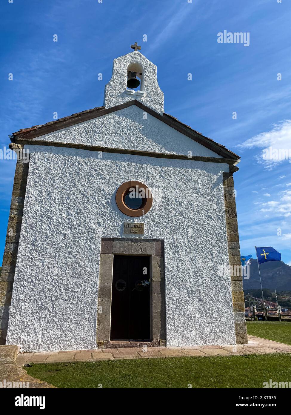 A vertical closeup of the Ermita de la Guia chapel in Ribadesella ...